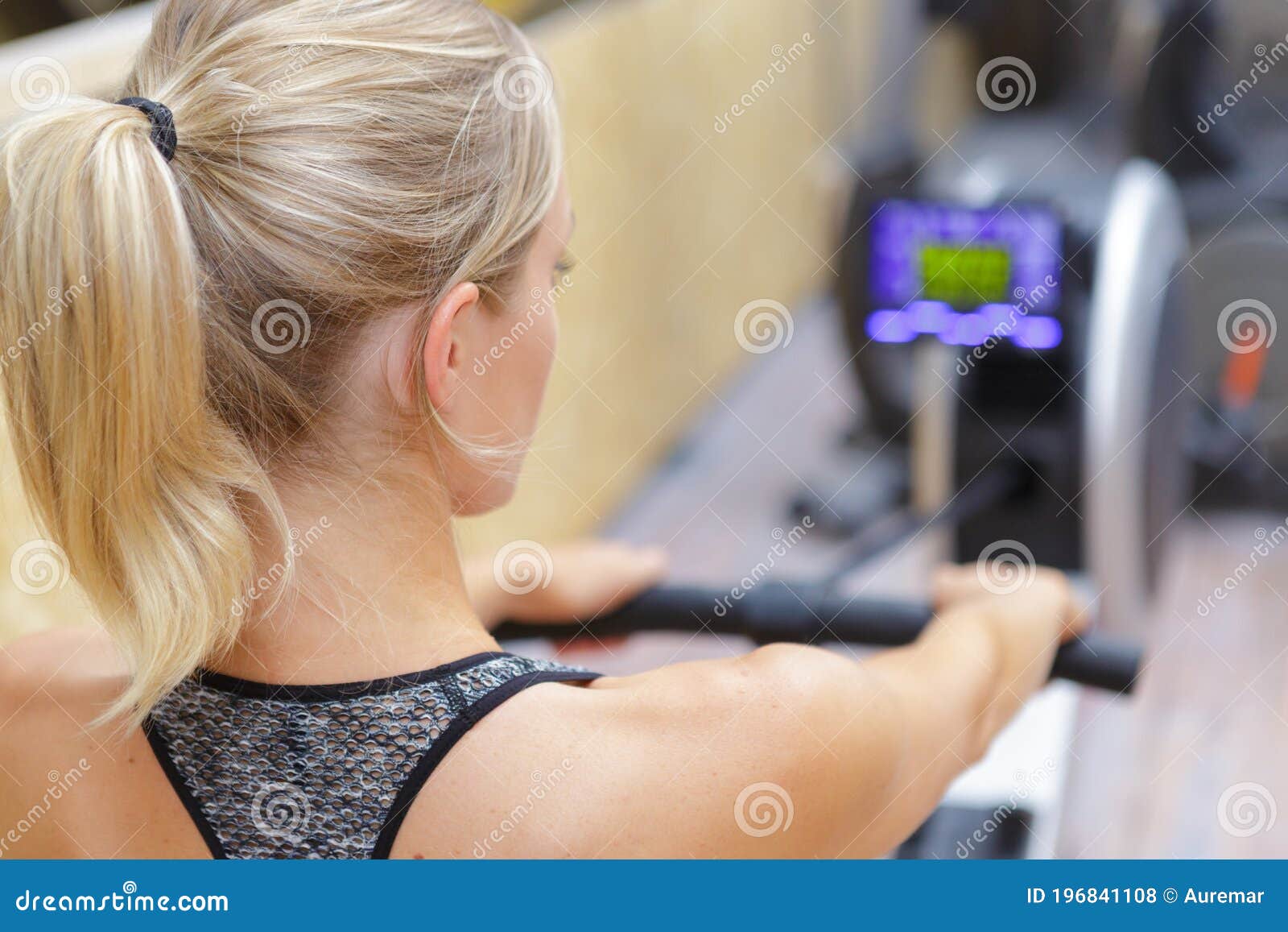 Woman on rowing machine stock photo. Image of machine - 196841108