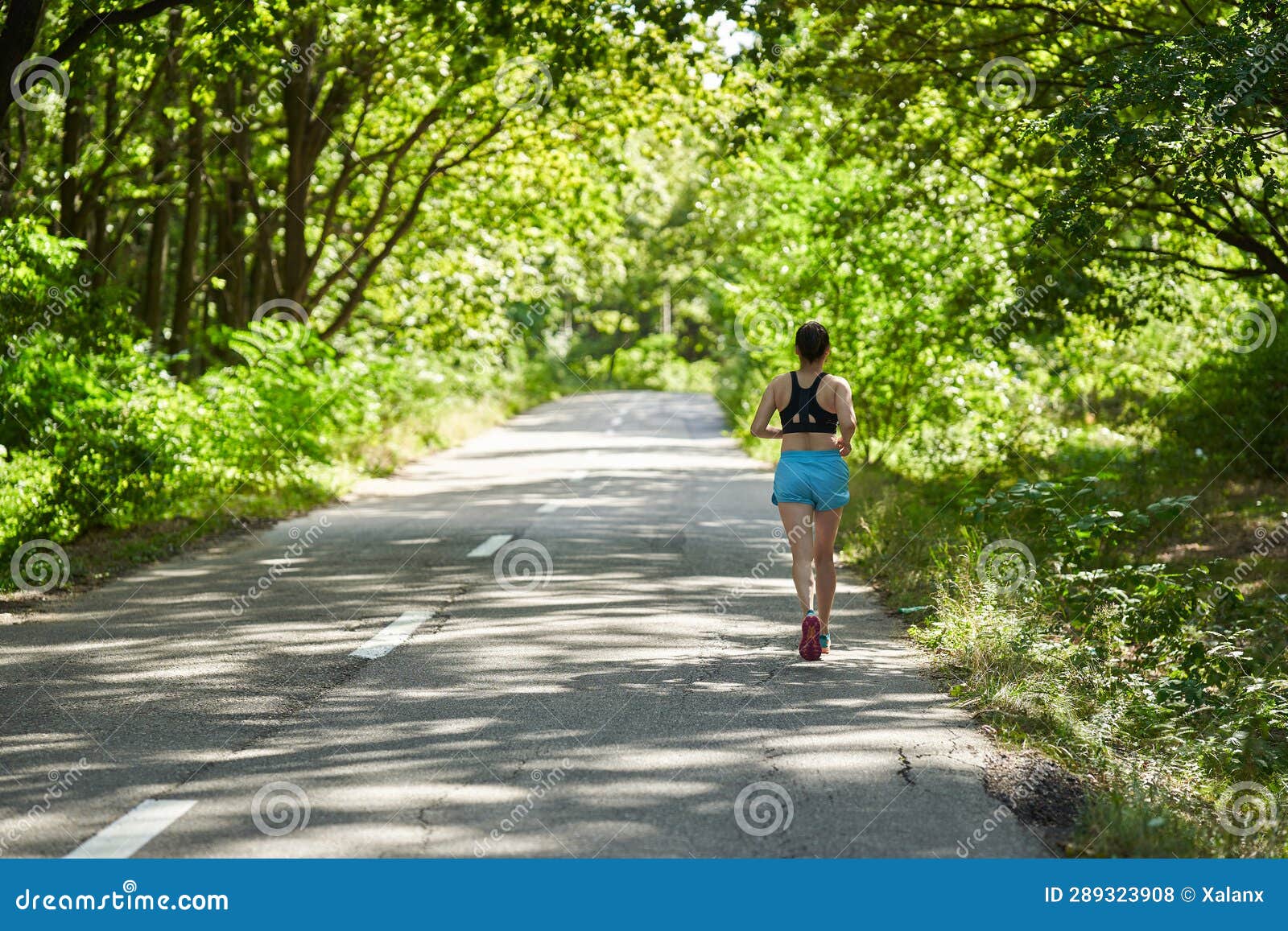 Woman Running through Forest on Asphalt Stock Photo - Image of jogger ...