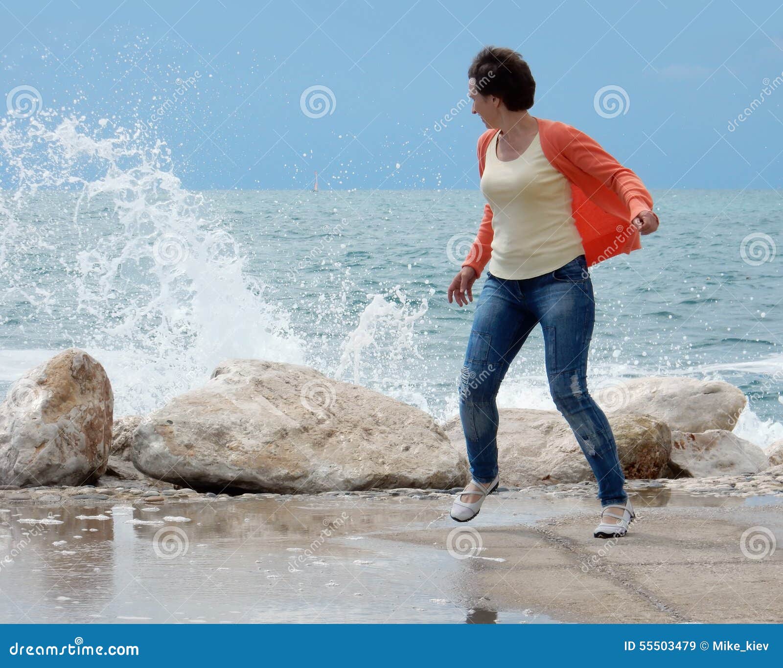 Woman Running Away from the Waves Stock Image - Image of waves, woman ...