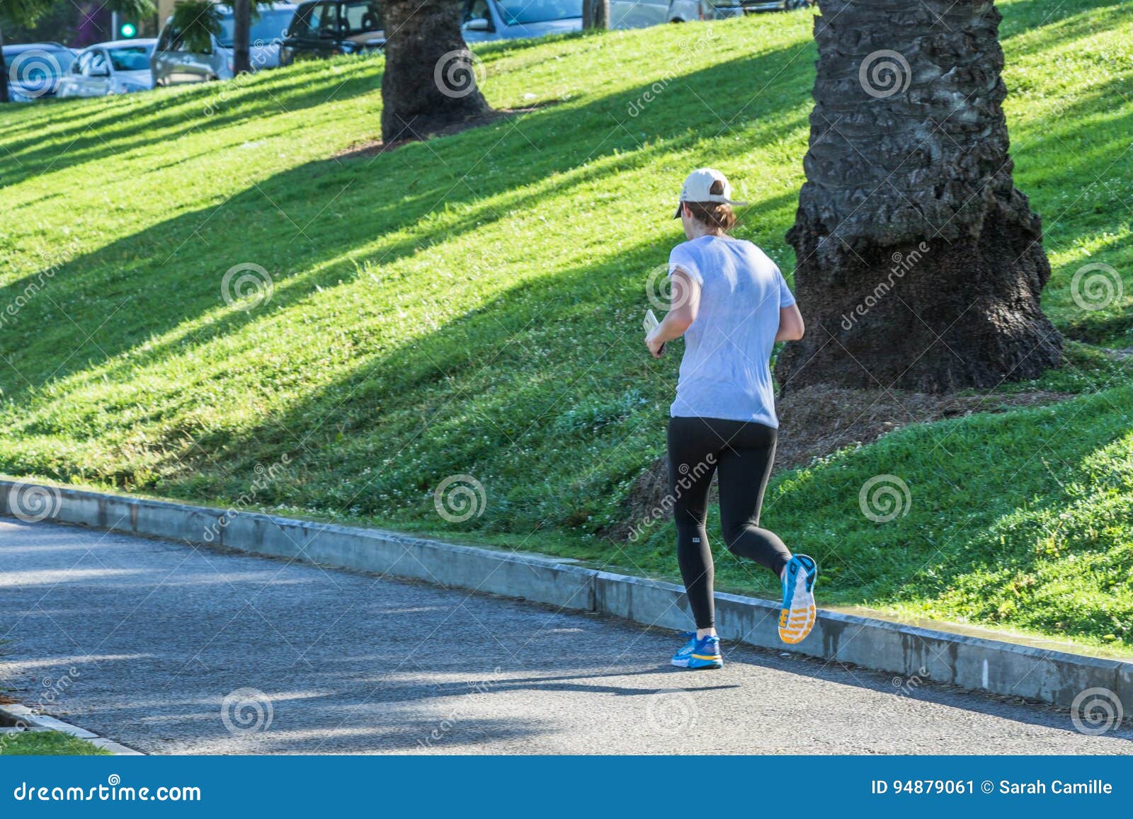Woman running in city park editorial photo. Image of city - 94879061