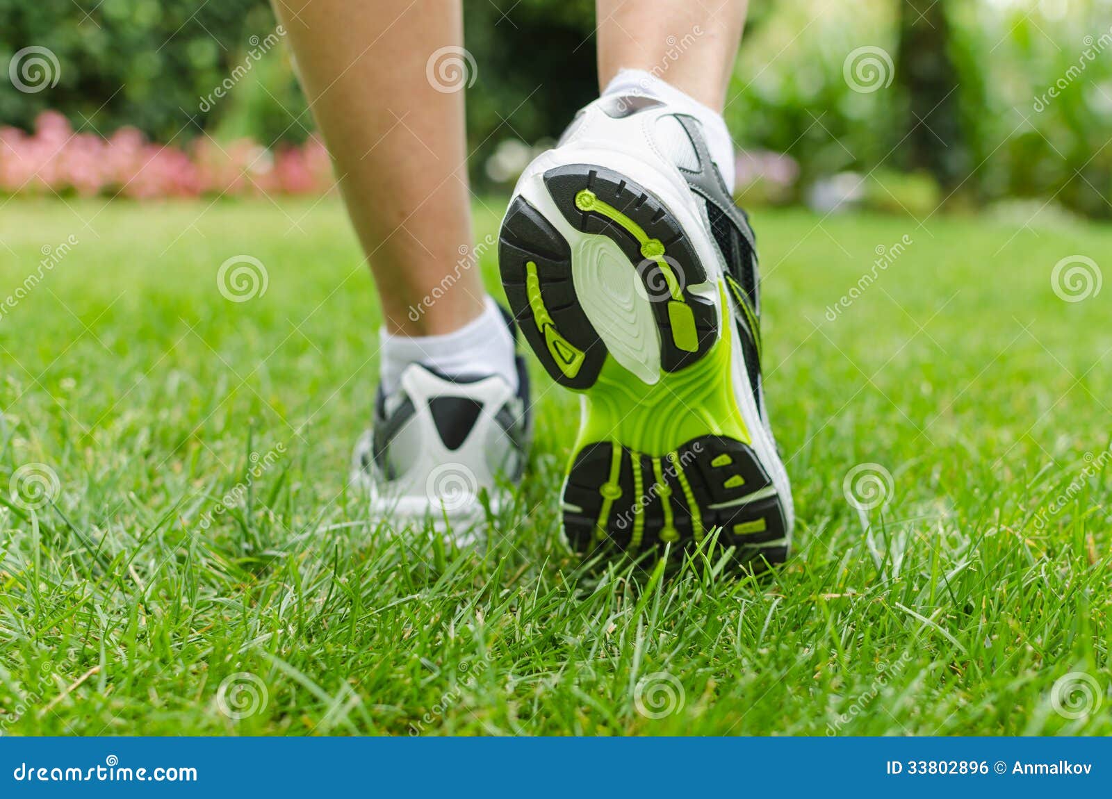 Woman running on grass stock photo. Image of footwear - 33802896