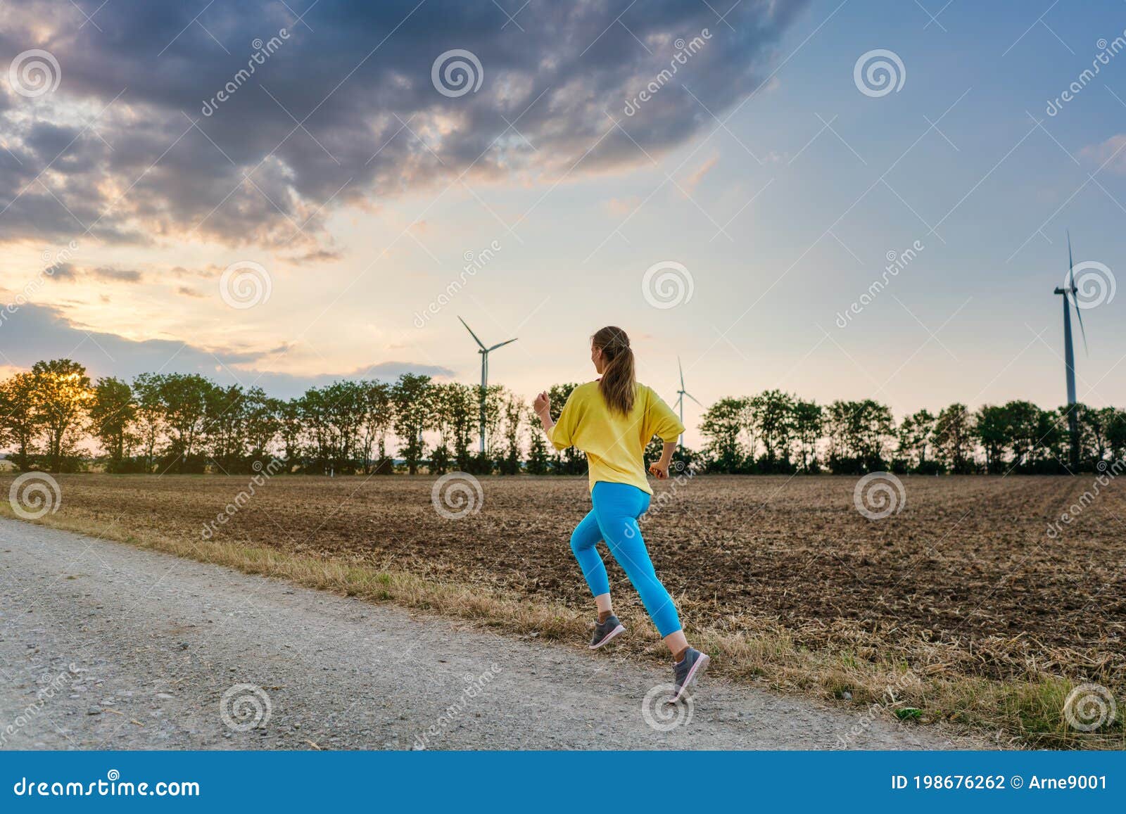 Woman Running or Jogging Down a Path in the Countryside Stock Photo ...