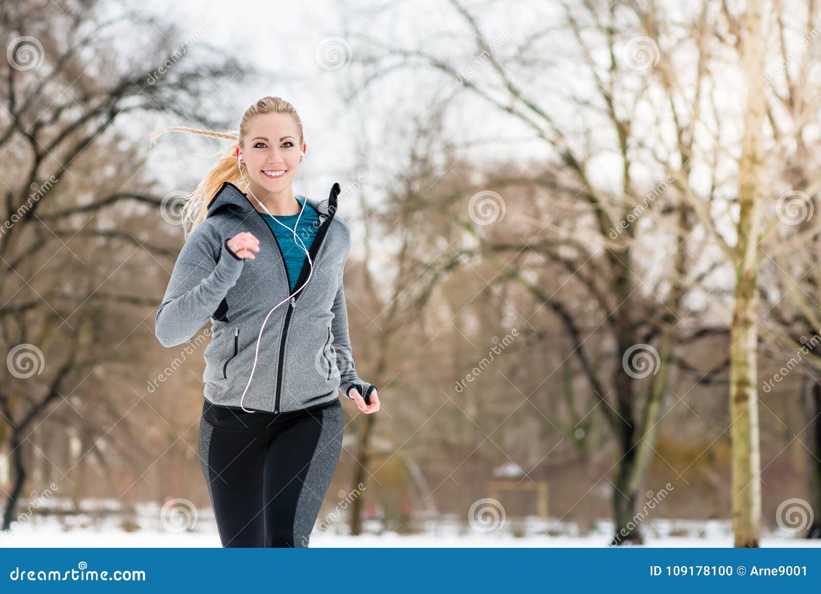 Woman Running Down a Path on Winter Day in Park Stock Photo - Image of ...