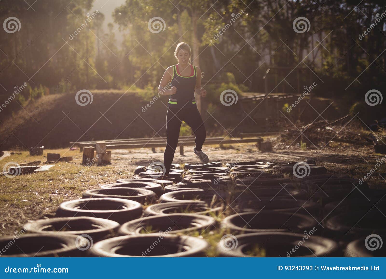 Woman Running Over Tyres during Obstacle Course Stock Image - Image of ...
