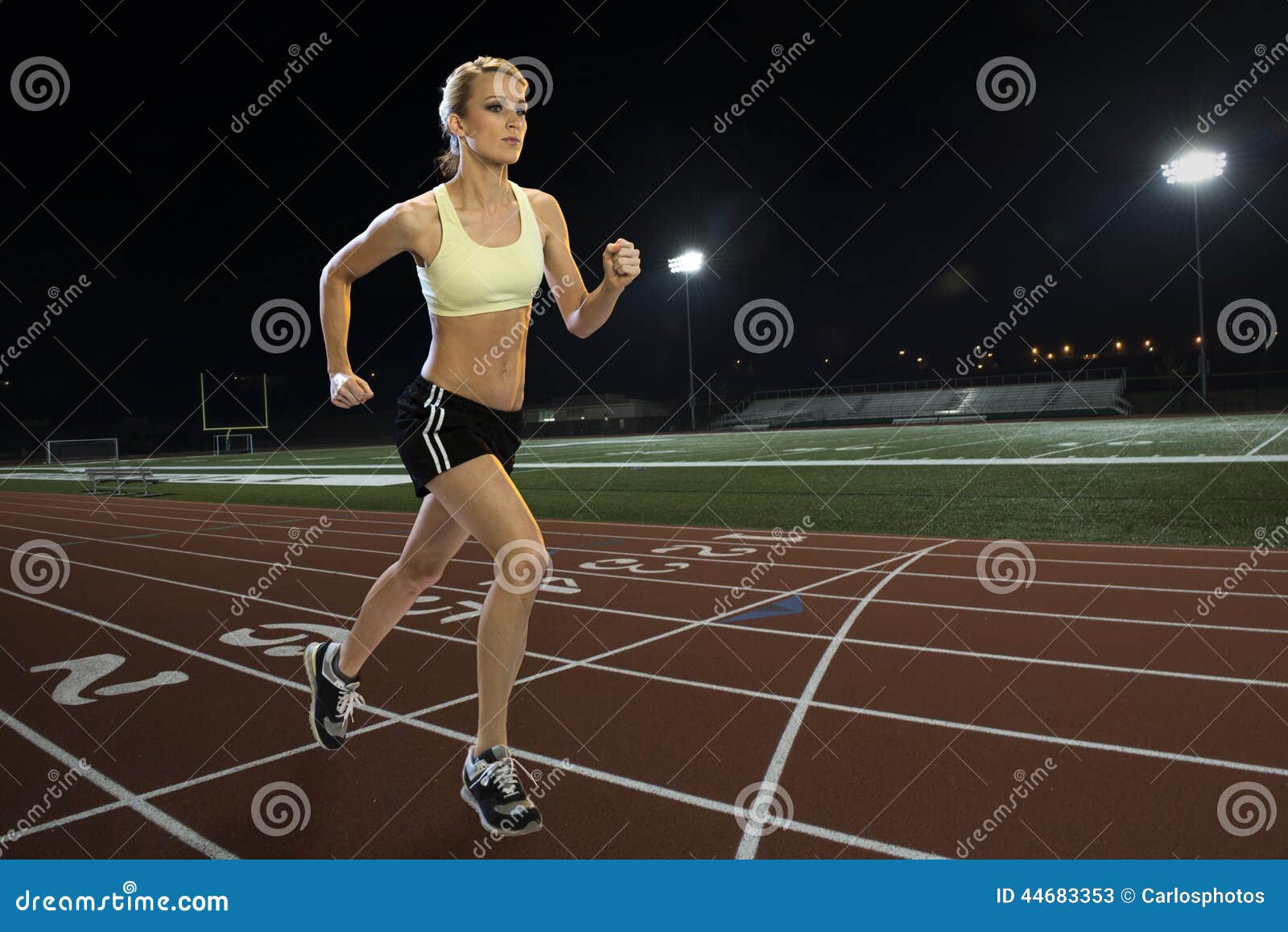 Woman running on a track stock image. Image of athletic - 44683353