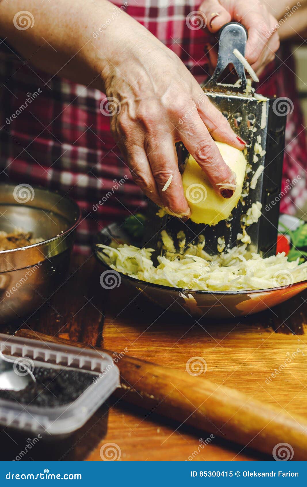 Woman`s Hand Grating Apple in Plate on Kitchen. Stock Image - Image of ...