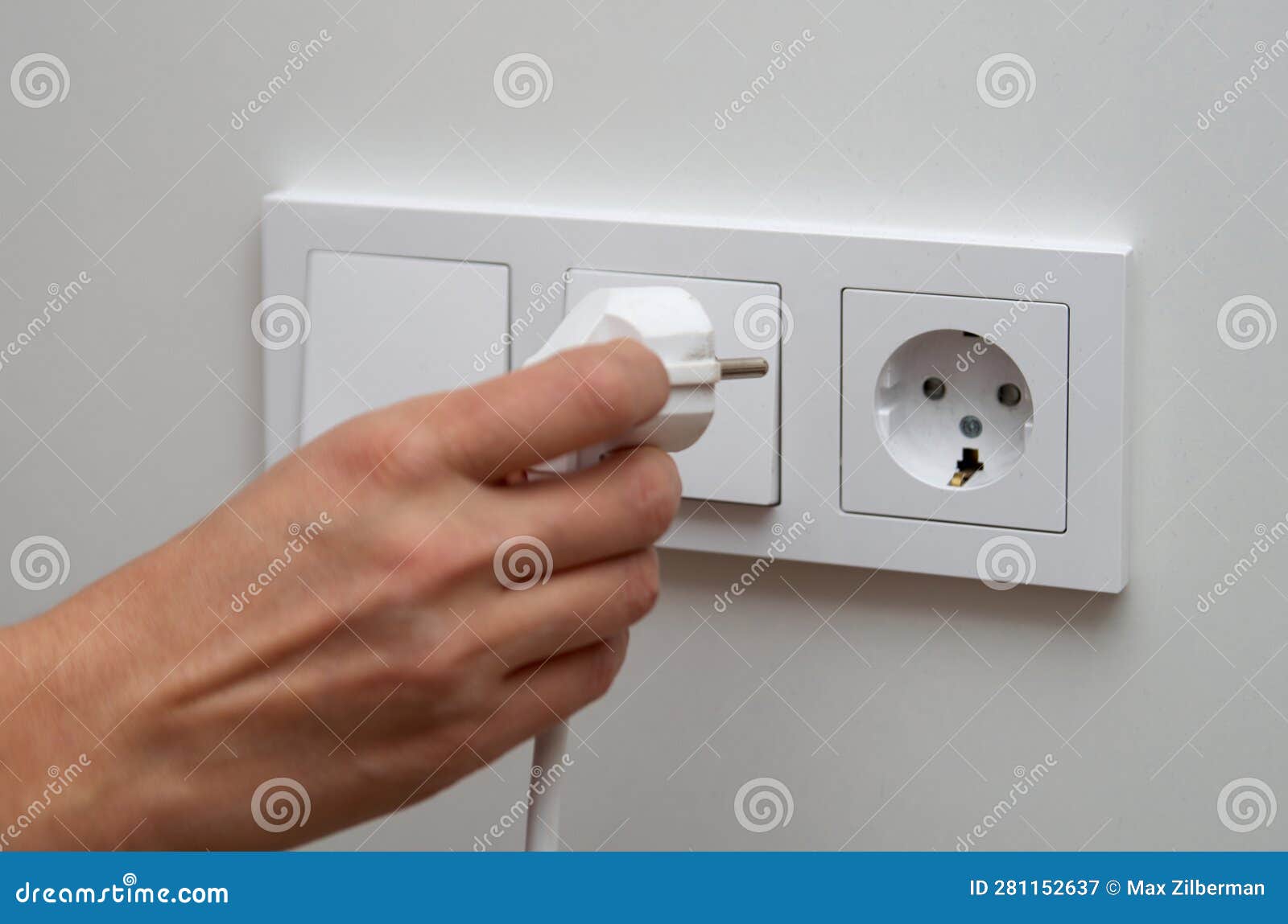 Woman S Hand Plugs an Electric Plug into a Socket Stock Image - Image ...