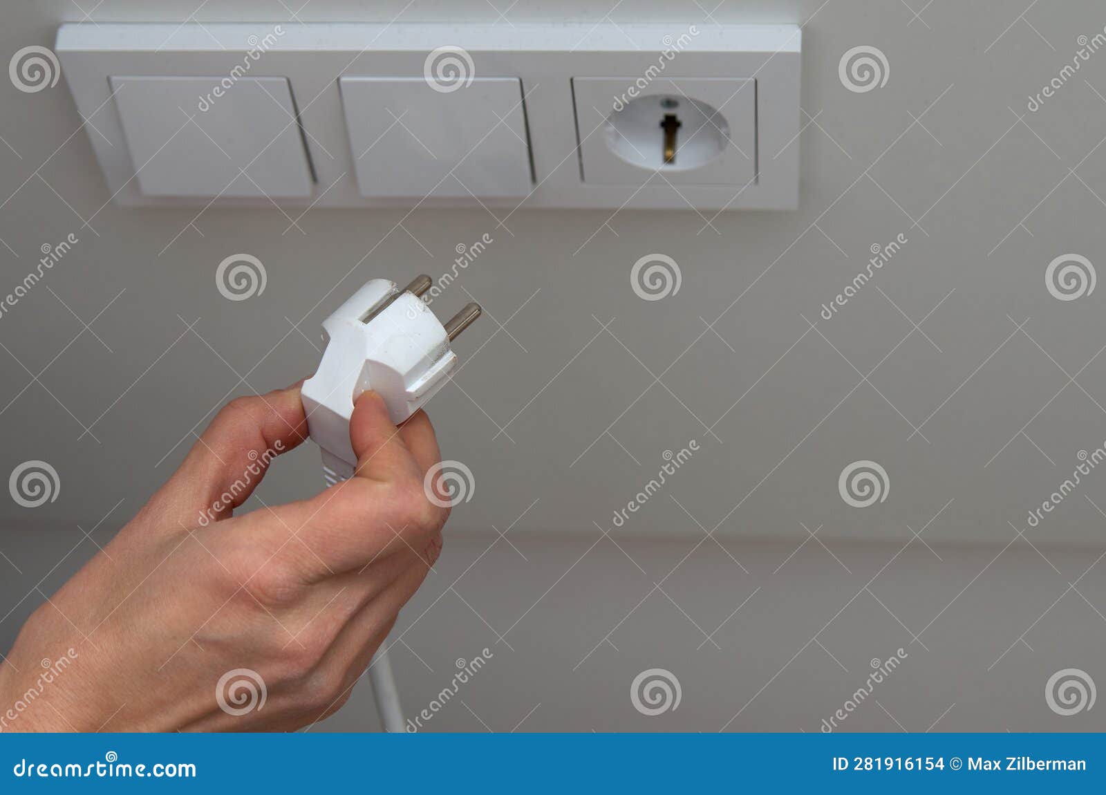 Woman S Hand Plugs an Electric Plug into a Socket Stock Photo - Image ...