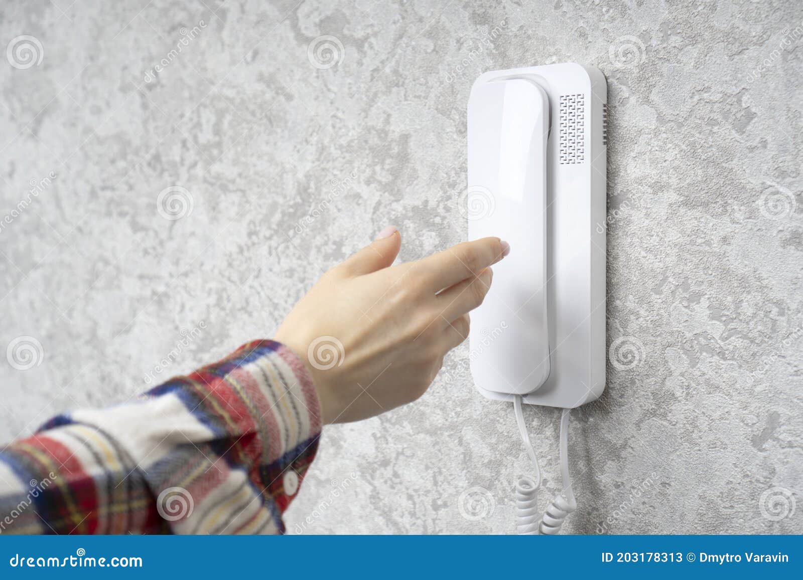 Woman`s Hand Reaches for the Intercom Receiver on the Wall Stock Image ...