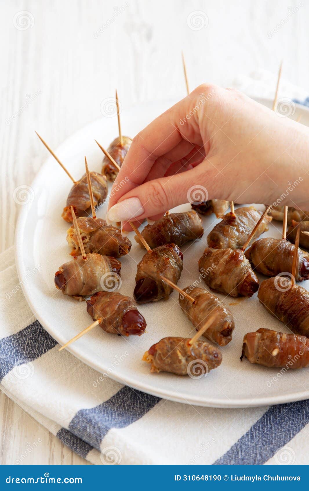A Woman S Hand Takes Bacon Wrapped Date, Side View Stock Photo - Image ...