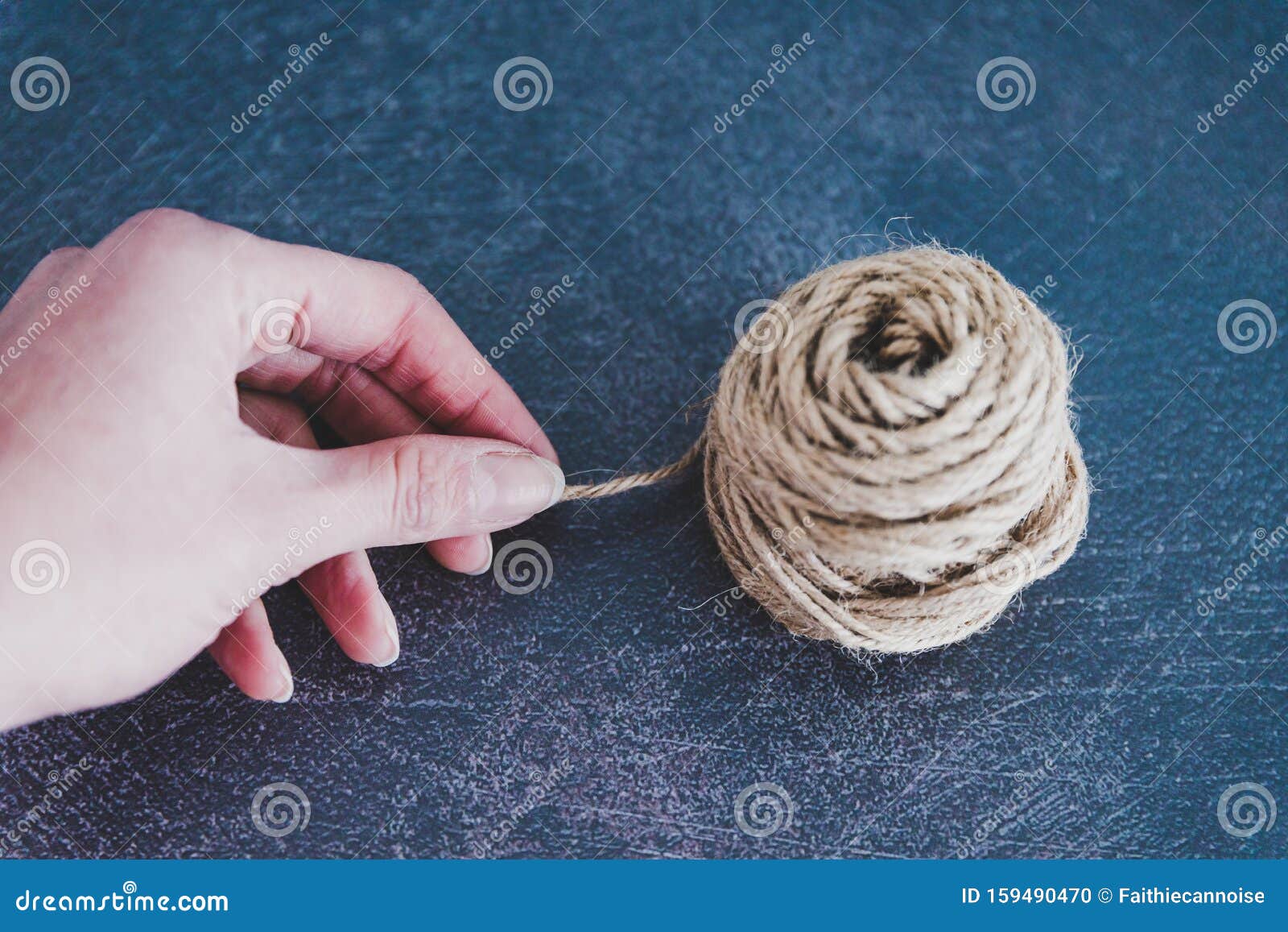 Woman`s Hand Untangling Ball of Thread by Pulling String Stock Photo ...