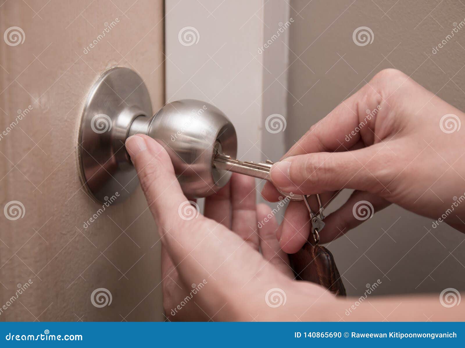 Woman`s Hand Using Key for Unlocking or Locking the White Door Stock ...