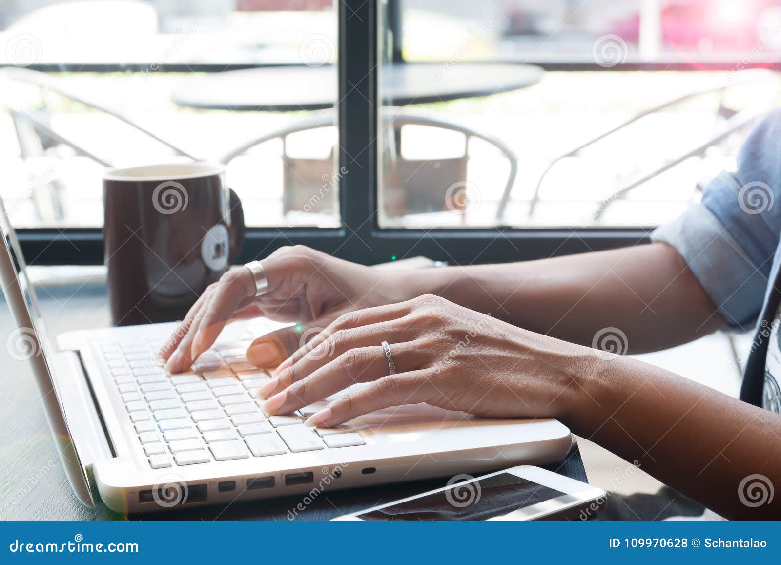 Woman`s Hand Using Laptop Computer and Mobile Device in Cafe, on Stock ...