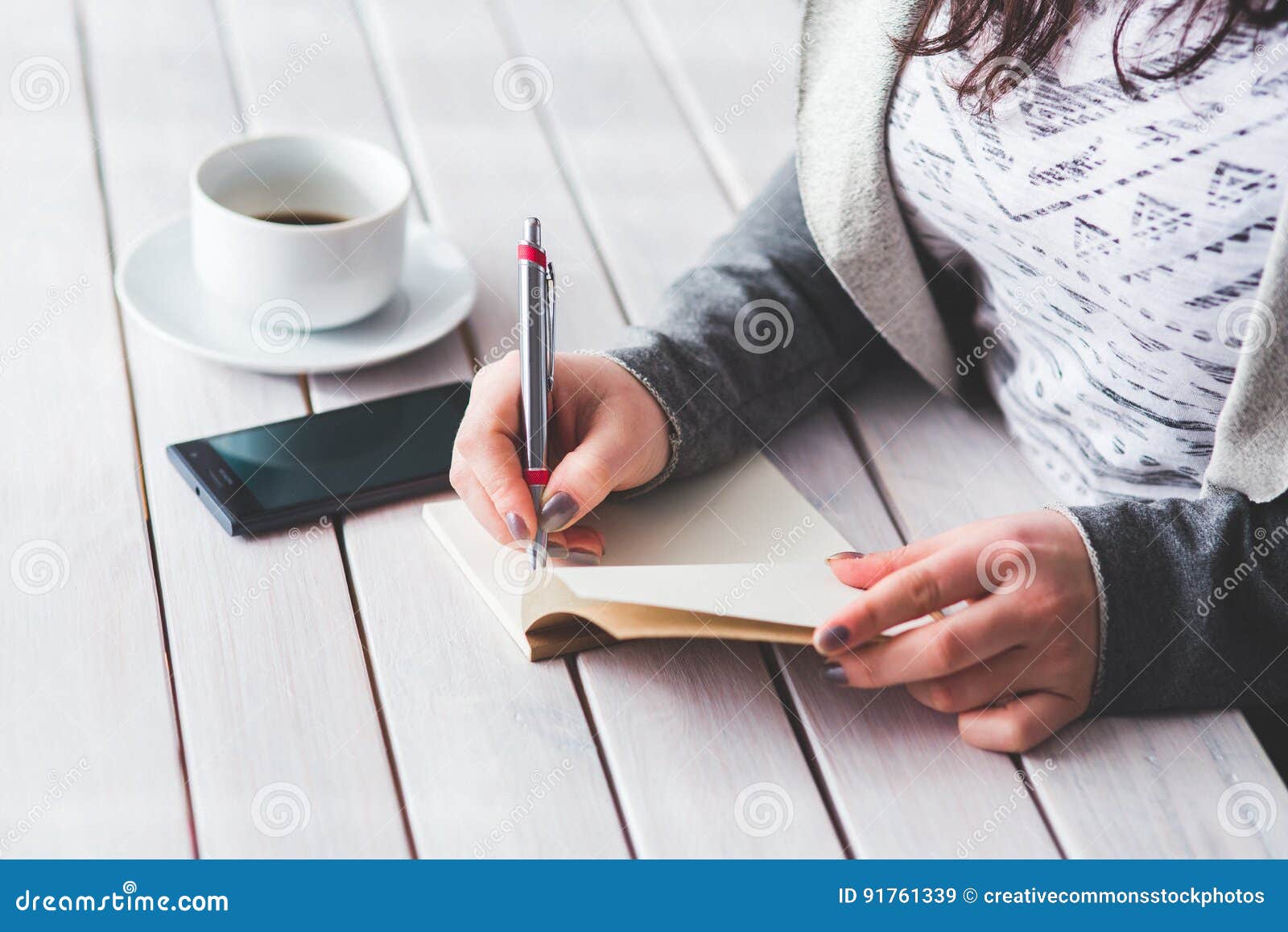 Woman's Hand Using A Pen Noting On Notepad Picture. Image: 91761339