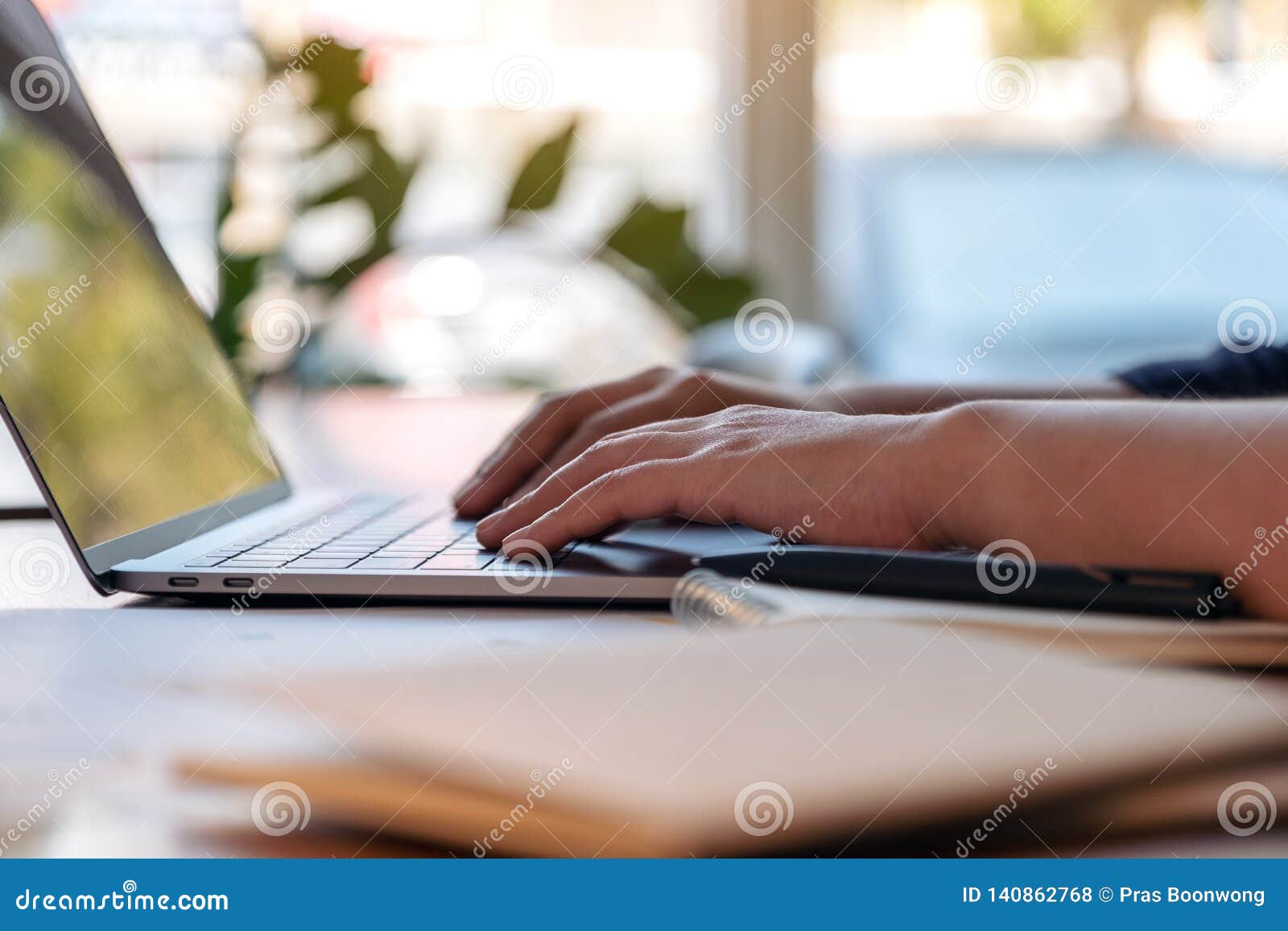 A Woman`s Hands Using and Typing on Laptop with Notebooks and Papers on ...