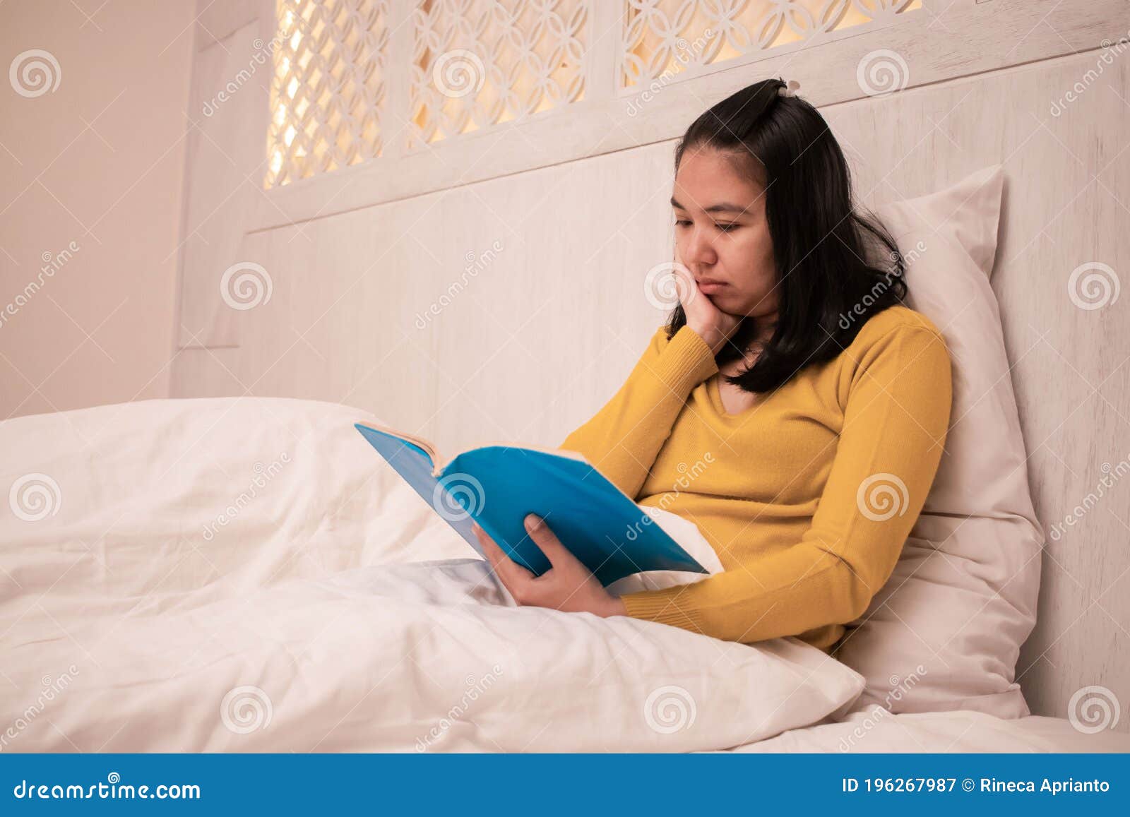 A Woman Sad while Reading a Book Stock Image - Image of leggings ...