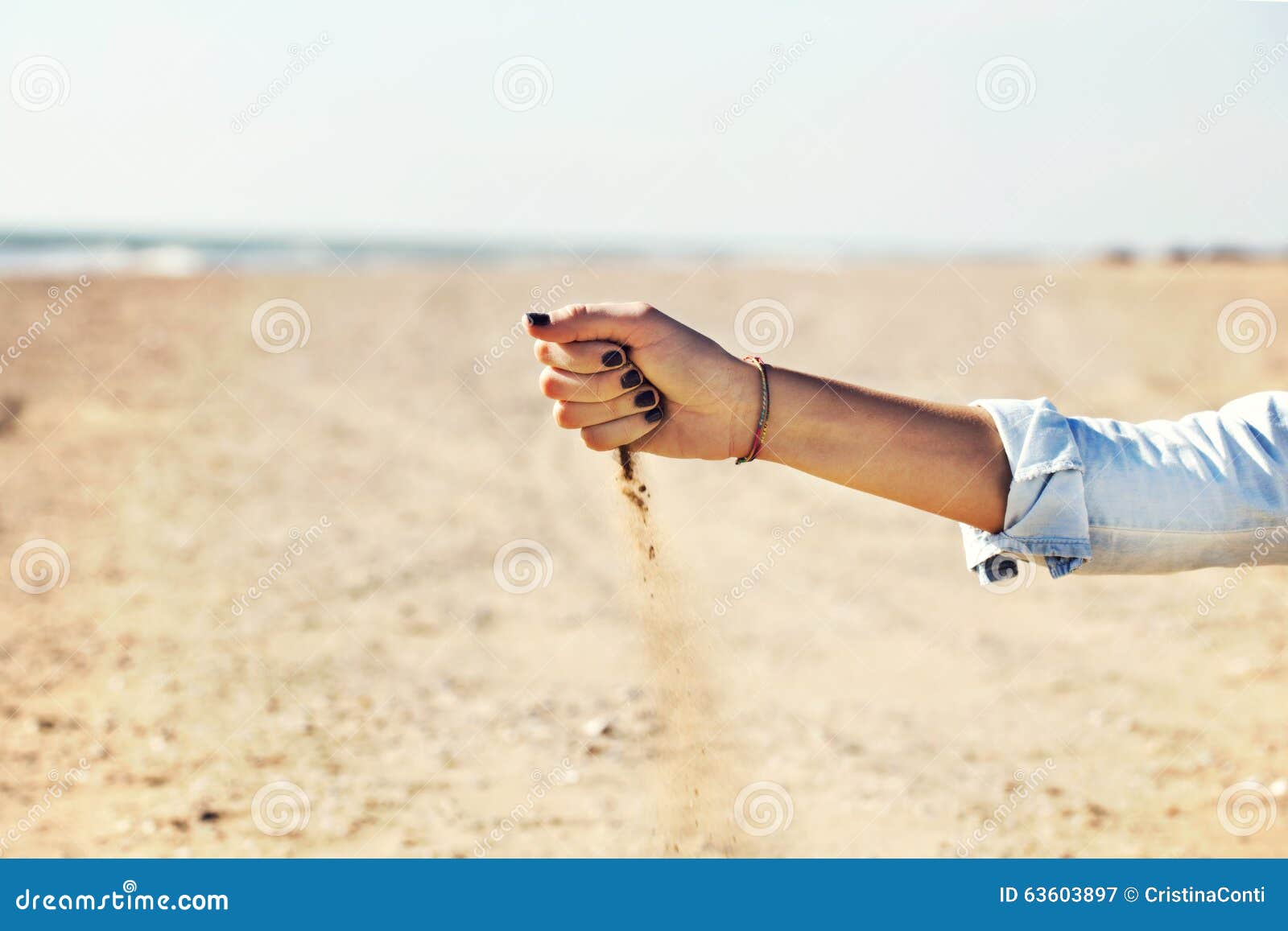 Woman with Sand Falling through Her Hands on the Beach Stock Image ...