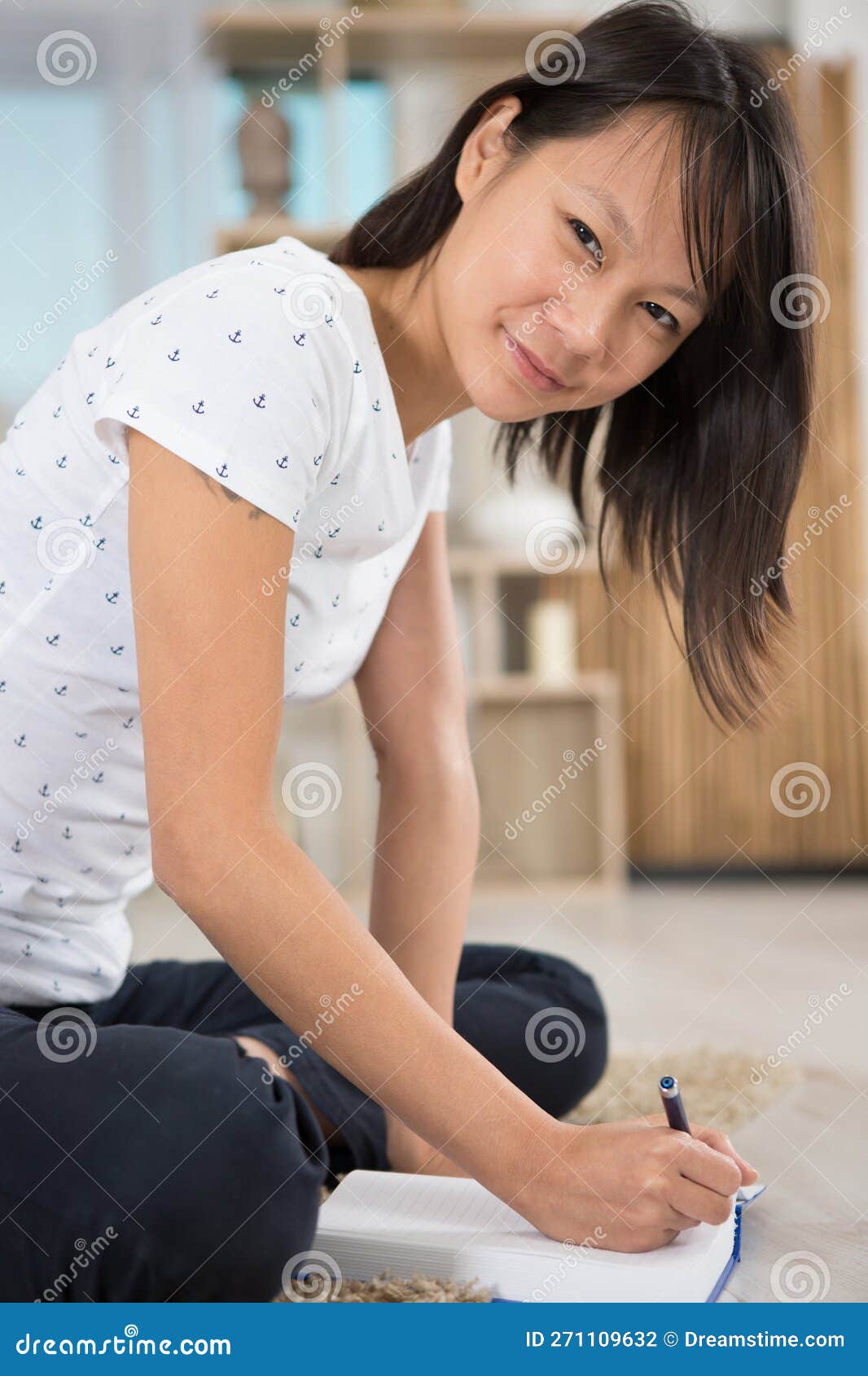 Woman Sat on Floor Writing in Notebook Stock Photo - Image of hair ...