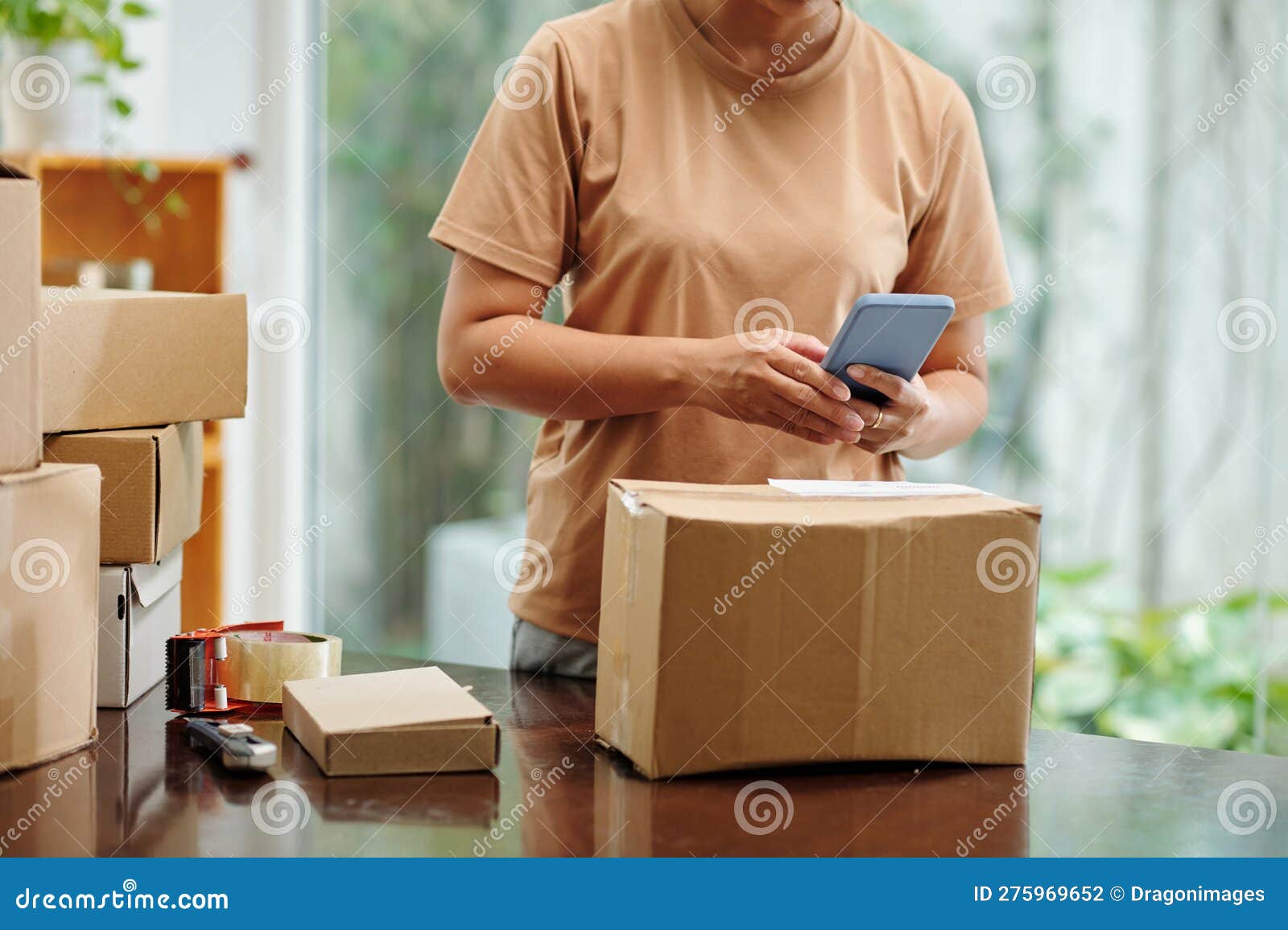 Woman Scanning Code on Parcel Stock Photo - Image of smartphone, delivery: 275969652