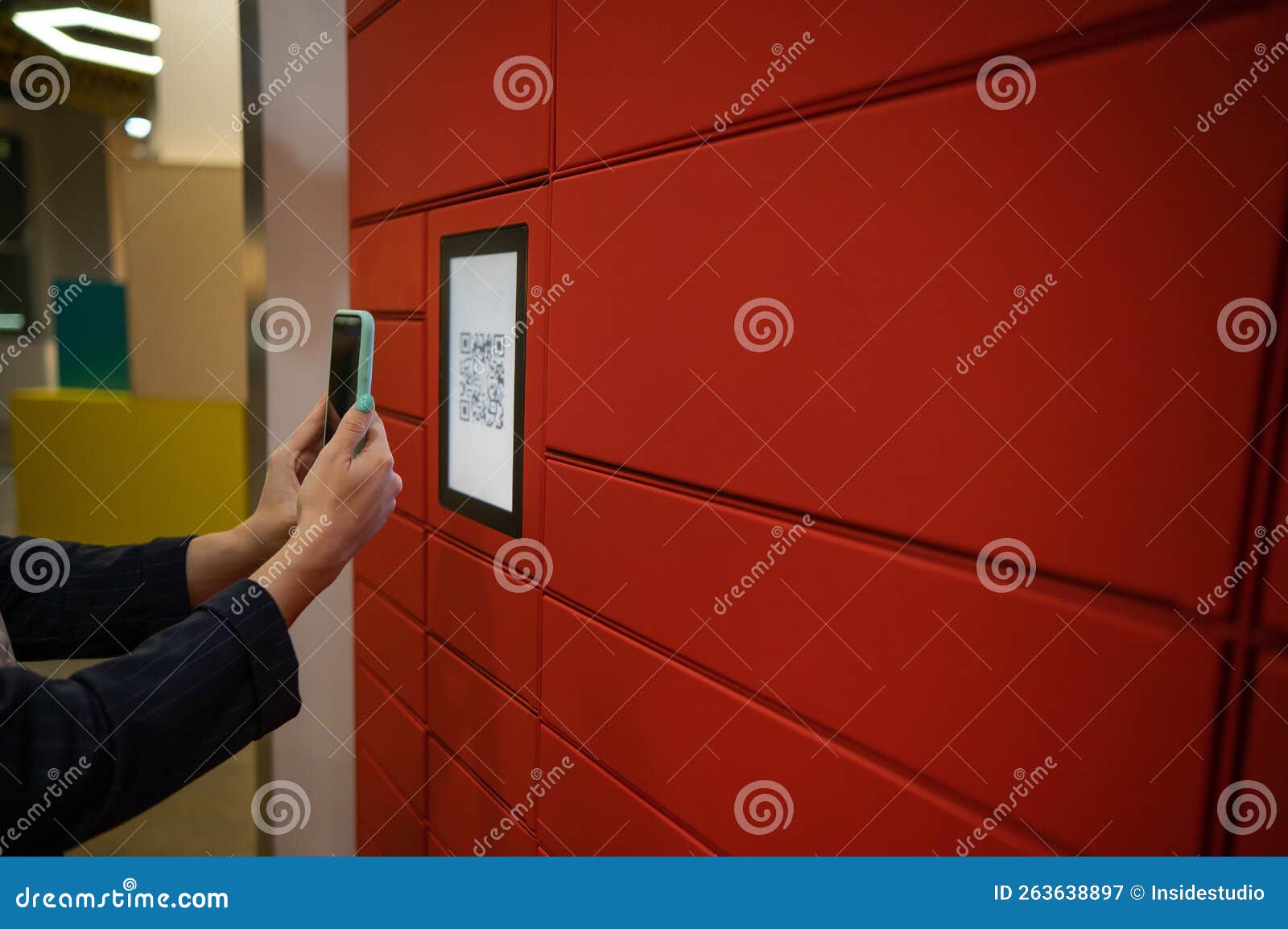 A Woman Scans a Red Code To Pick Up a Parcel at a Parcel Machine ...