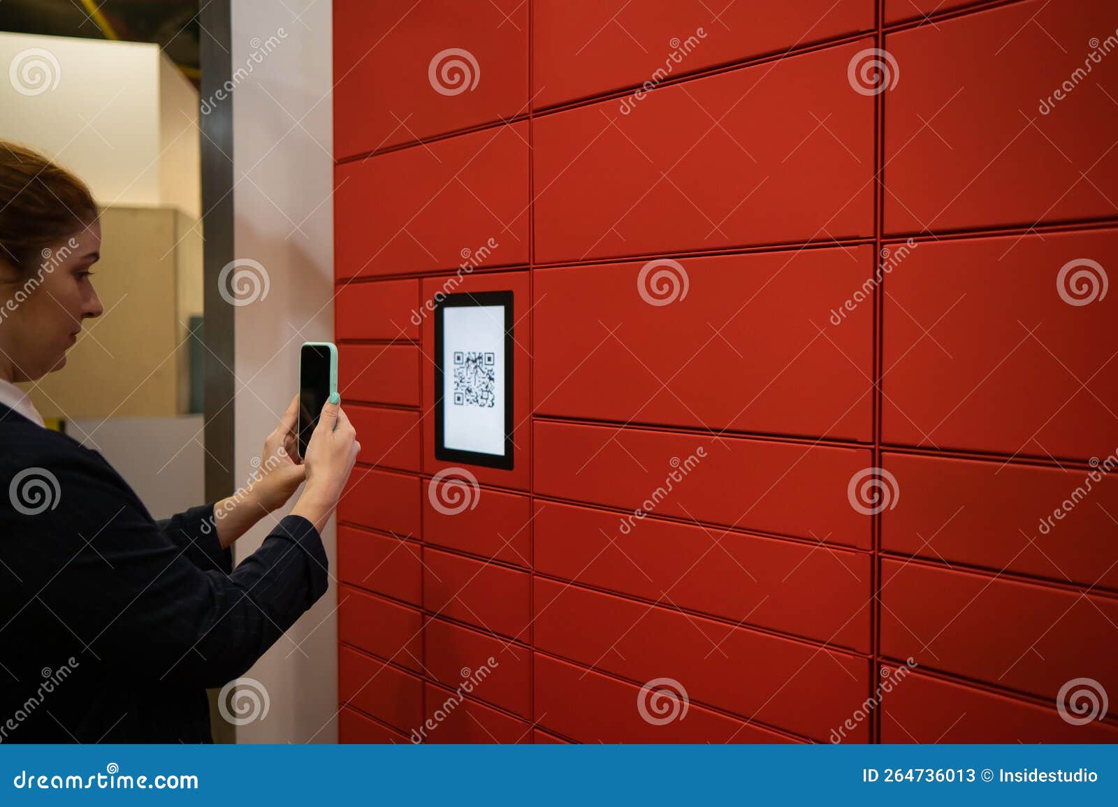 A Woman Scans a Red Code To Pick Up a Parcel at a Parcel Machine ...