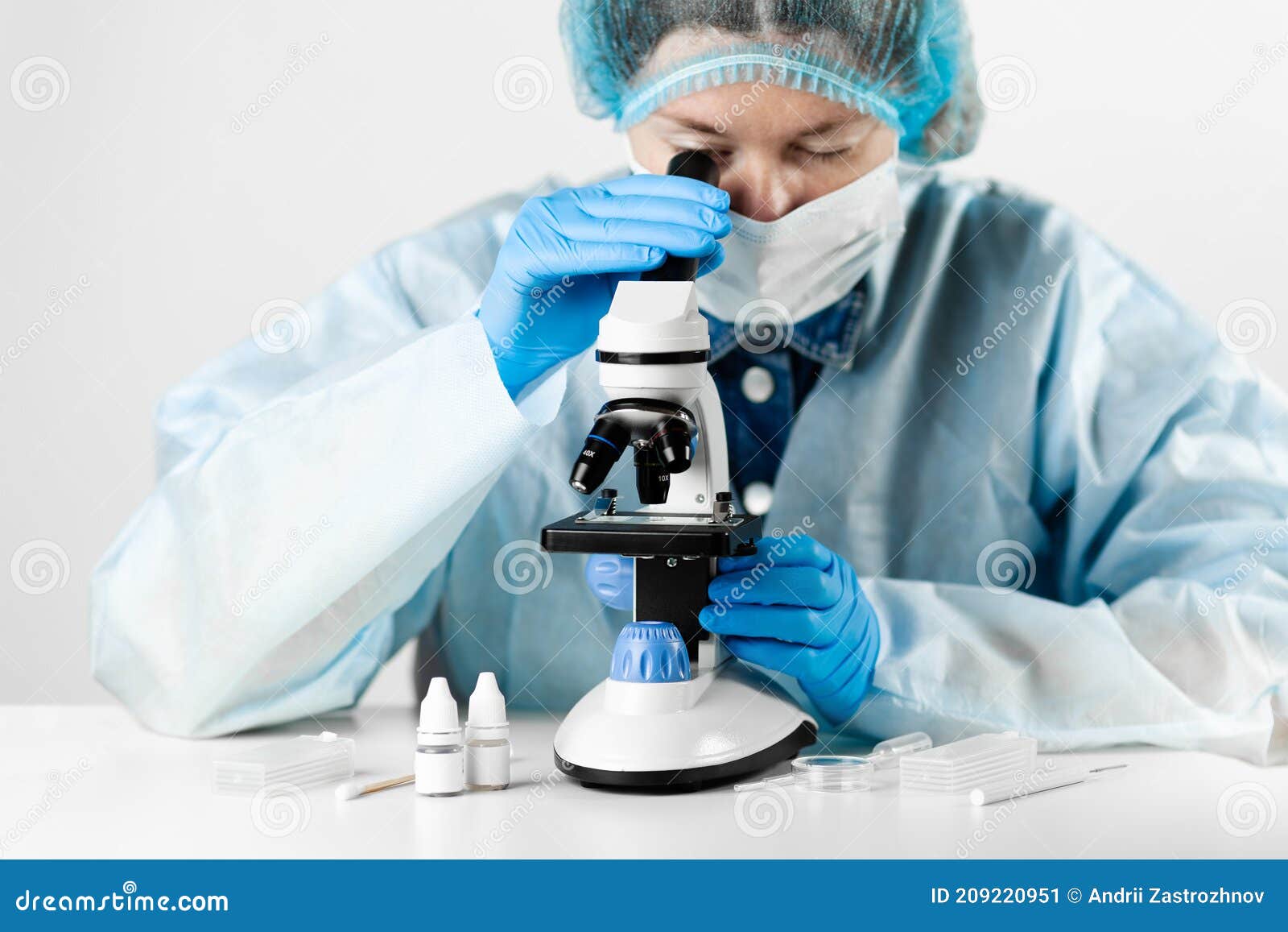 Woman Scientist Looks through a Microscope. Forensic Investigation ...