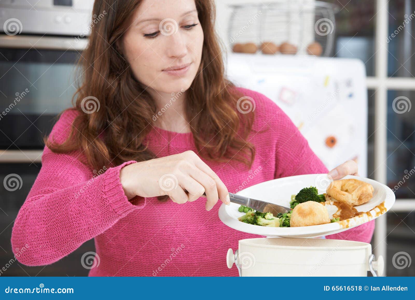 Woman Scraping Food Leftovers into Garbage Bin Stock Photo - Image of ...