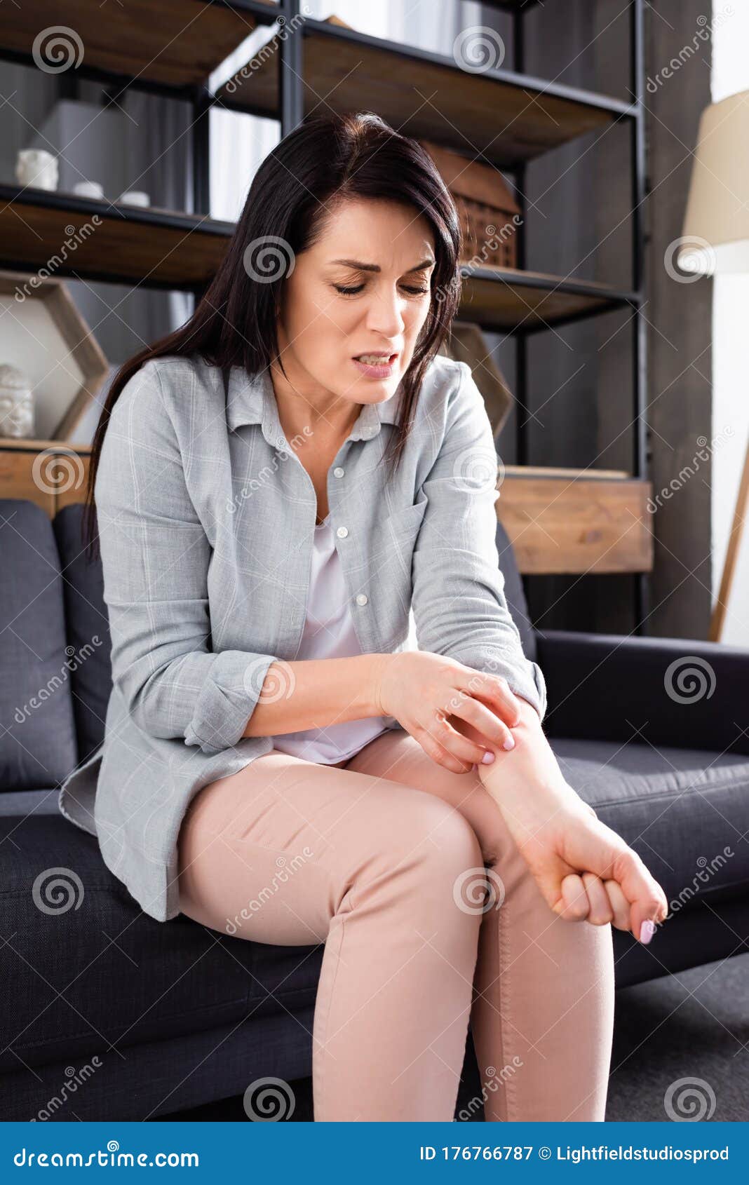 Woman Scratching Hand while Sitting on Sofa Stock Image - Image of ...