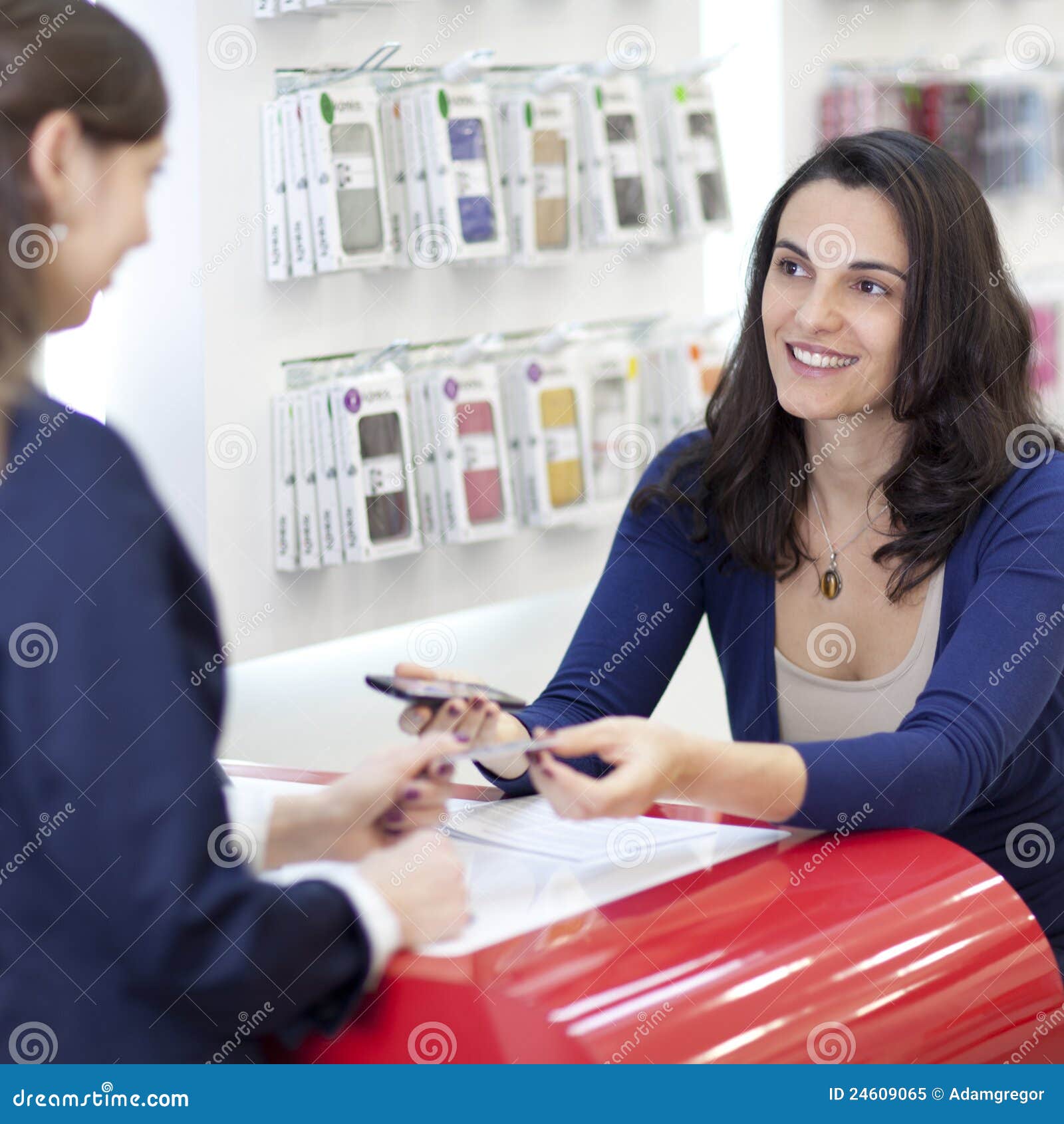 Woman selling a cell phone stock image. Image of people - 24609065