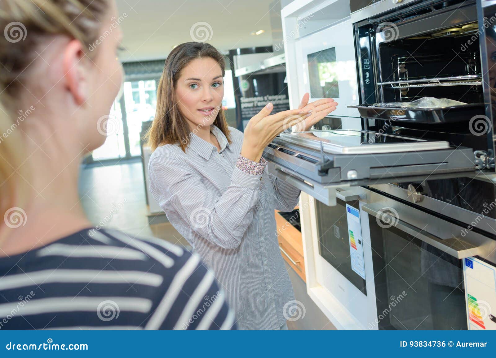 Woman Selling Kitchen Oven in Store Stock Photo - Image of satisfied ...