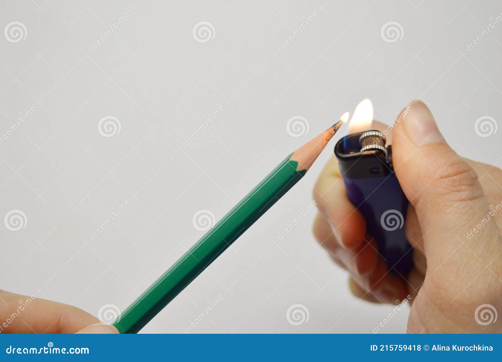 Woman Setting Fire To Pencil Lead with Lighter on White Background ...