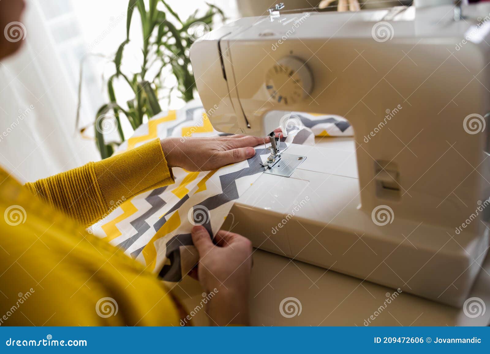 Woman Sewing on a Sewing Machine at Her Home Stock Photo - Image of ...