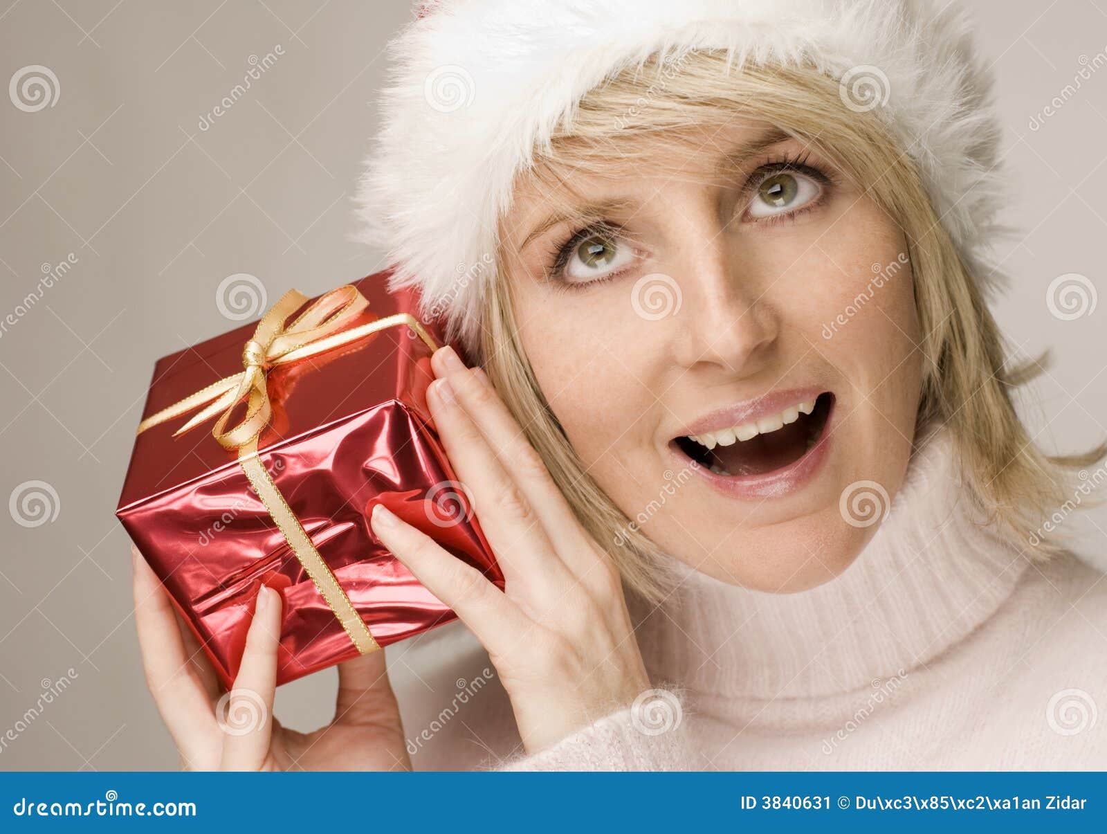 Woman shaking gift stock image. Image of listens, cube - 3840631