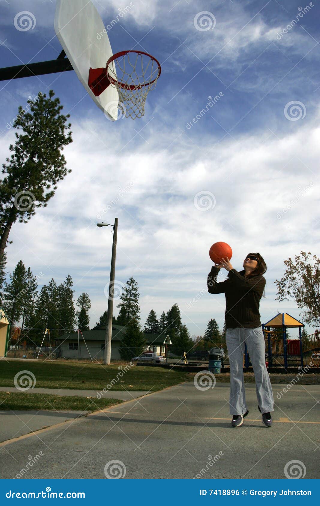 Woman shoots a basketball. stock photo. Image of hold - 7418896