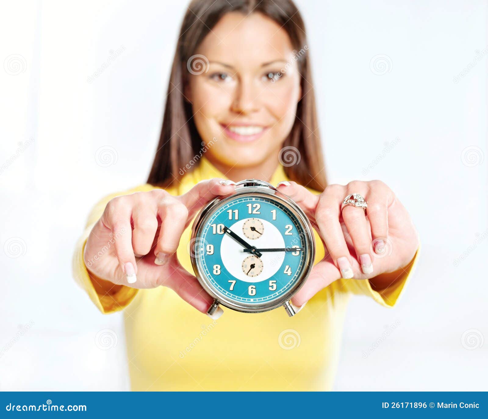 Woman showing alarm clock stock photo. Image of brunette - 26171896