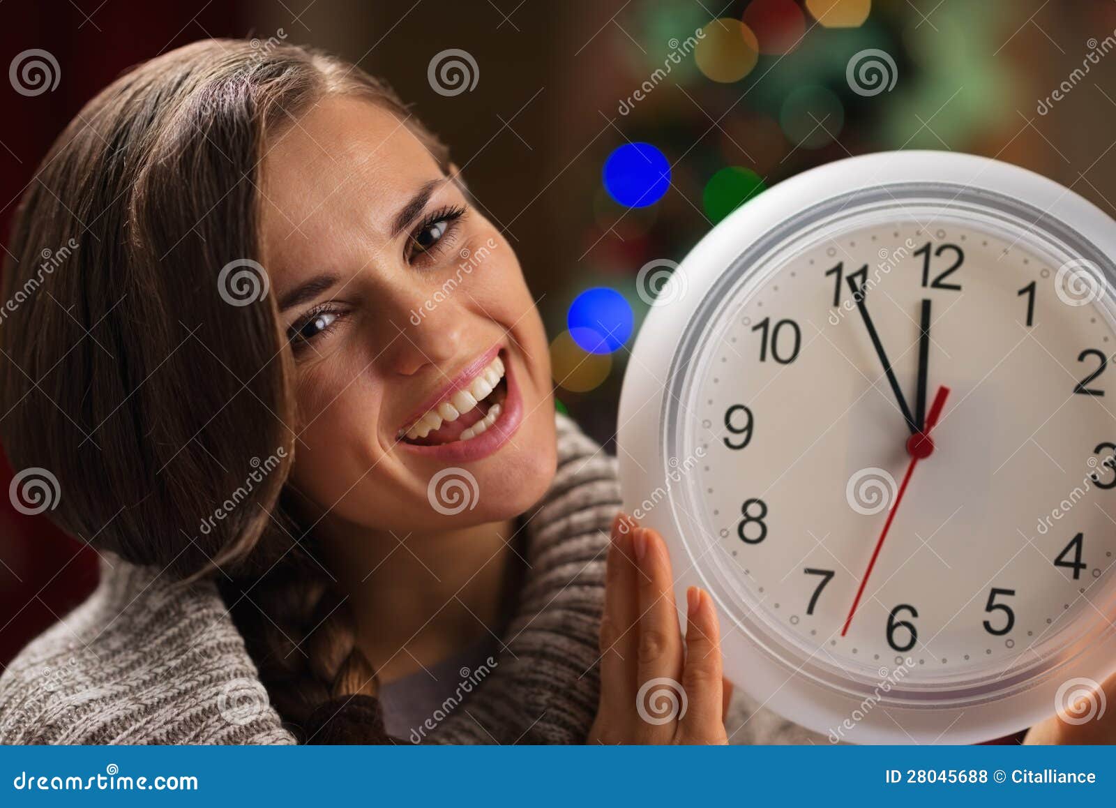 Woman Showing Clock in Front of Christmas Tree Stock Photo - Image of ...