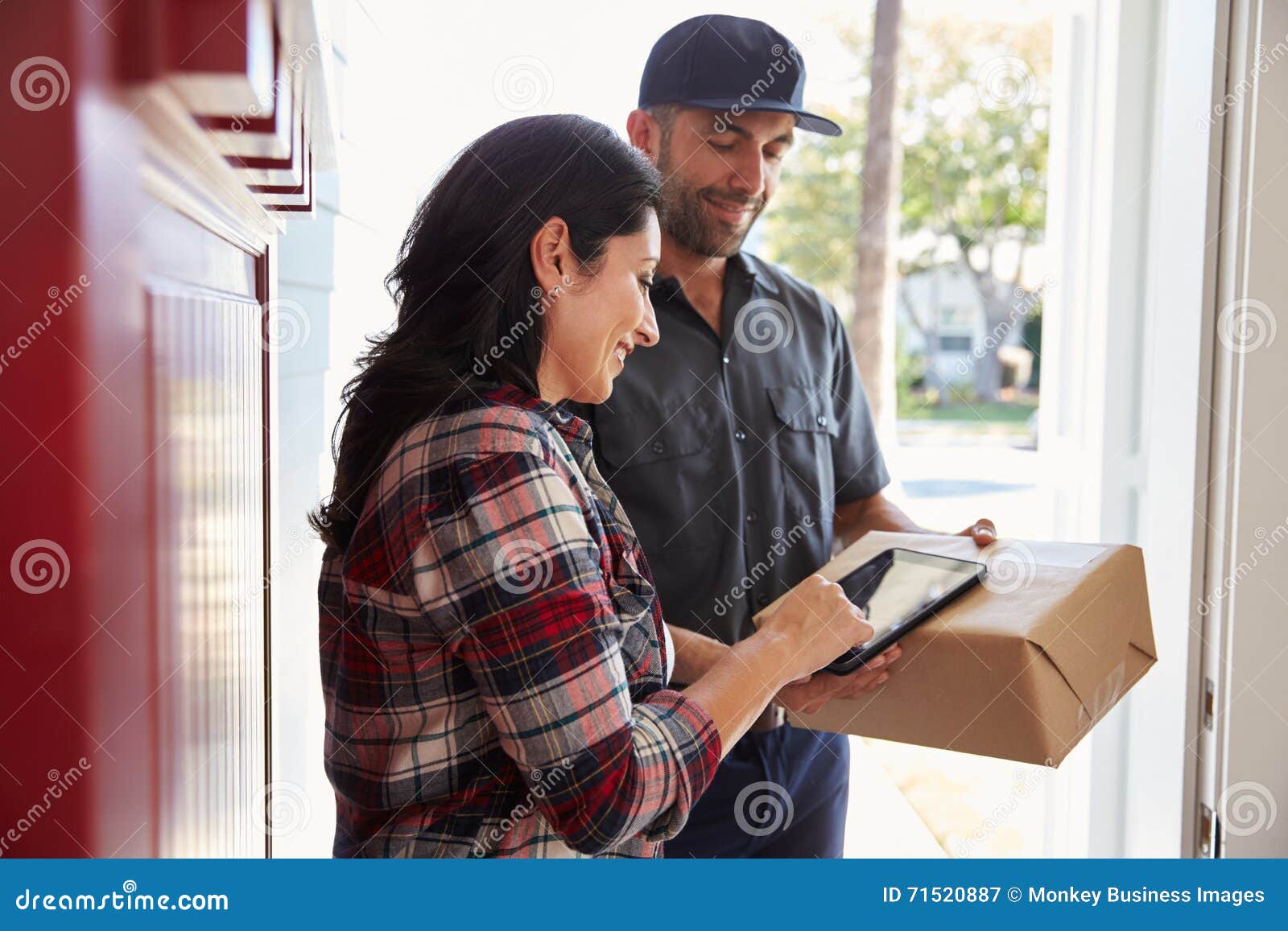 Woman Signing for Package from Courier at Home Stock Image - Image of ...