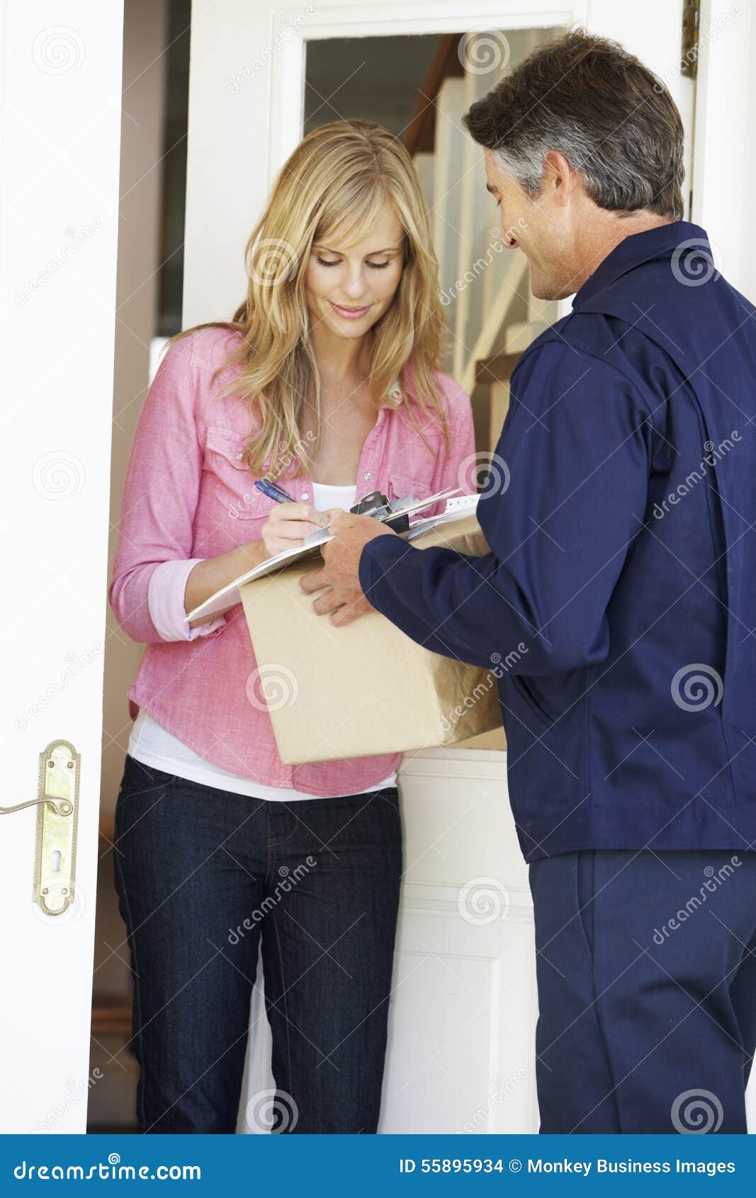 Woman Signing for Package Delivered by Courier Stock Photo - Image of ...