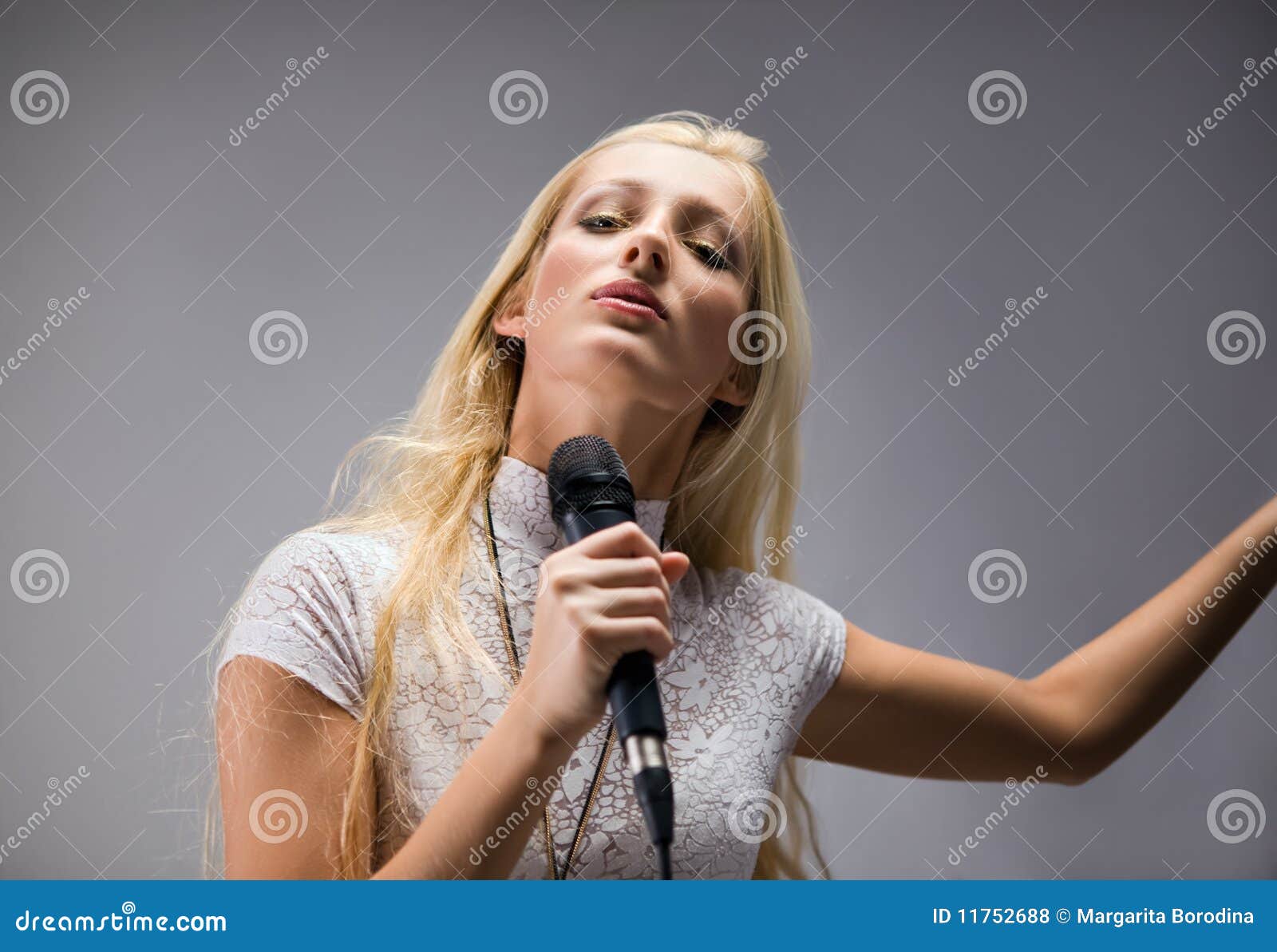 Woman Singing into a Microphone Stock Photo - Image of performace ...