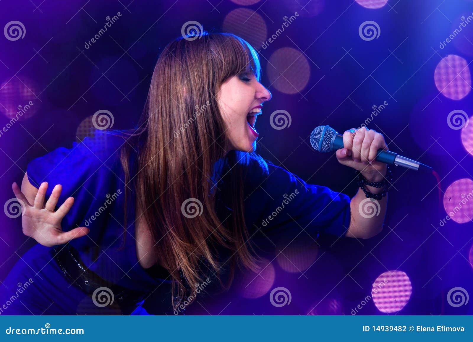 Woman Singing into Microphone Stock Photo - Image of holding, action ...