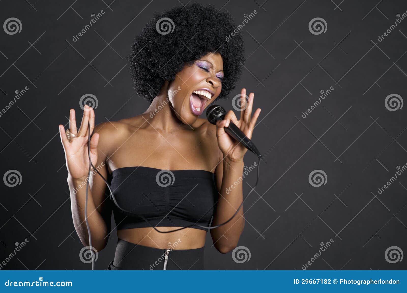 Woman Singing on Microphone Over Colored Background Stock Photo - Image ...
