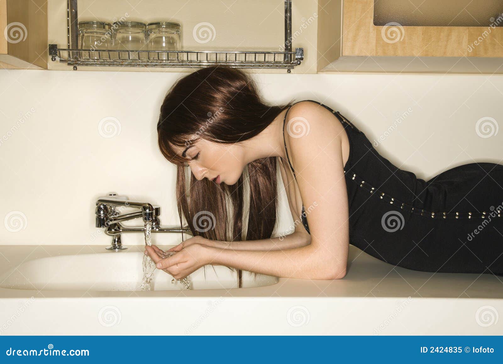 Woman at sink. stock image. Image of drink, years, drinking - 2424835