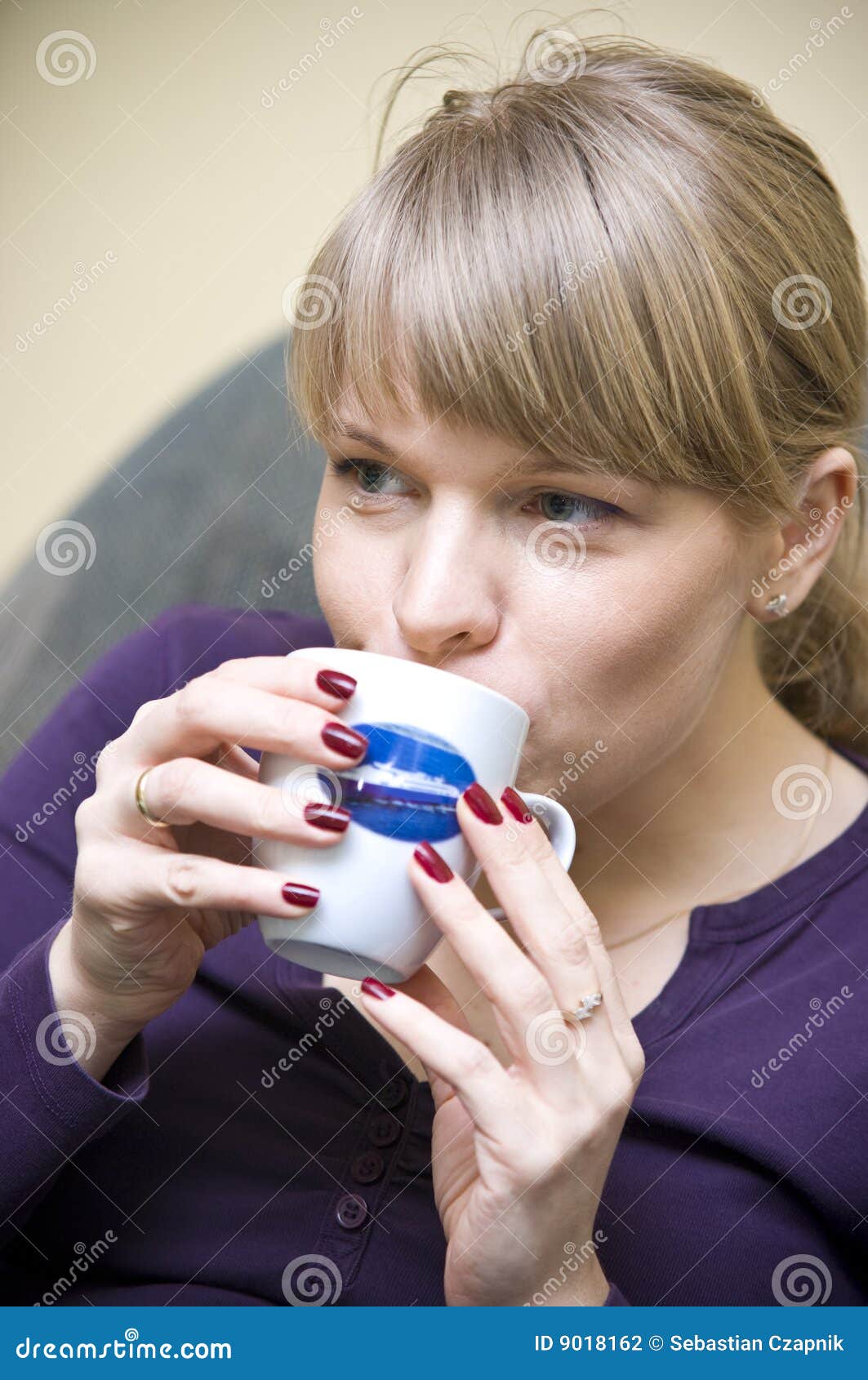 Woman sipping coffee stock photo. Image of sits, coffee - 9018162