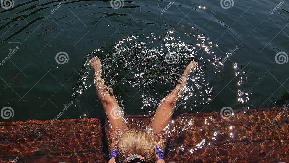Woman Sit On A Pier In Sunglasses And Swimming Suit Girl Rest On A