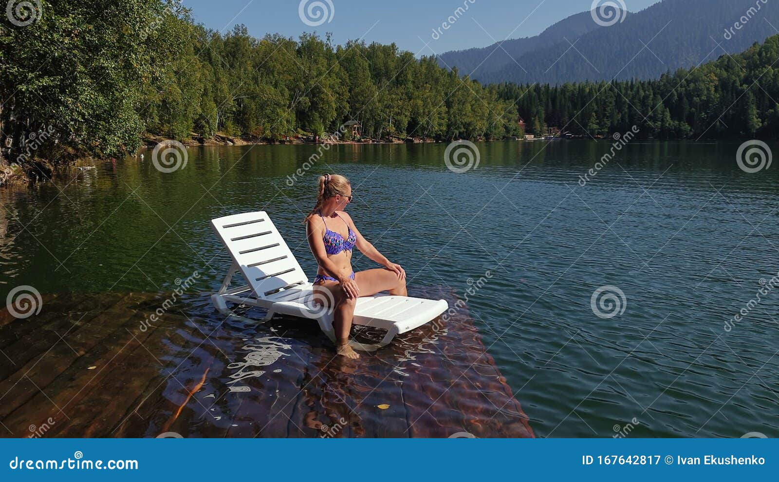 Woman Sit On A Sunbed In Sunglasses And Swimming Suit Girl Rest On A