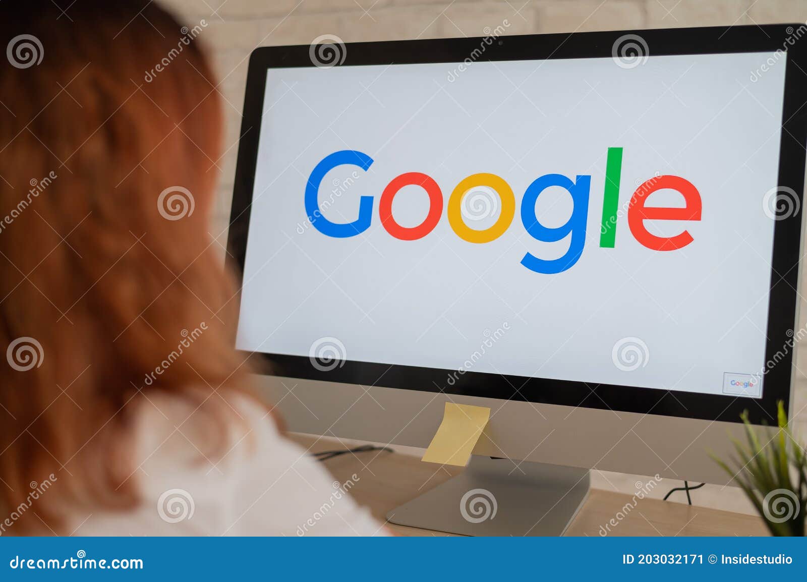 A Woman Sits at a Computer with a Google Logo on the Monitor Editorial ...