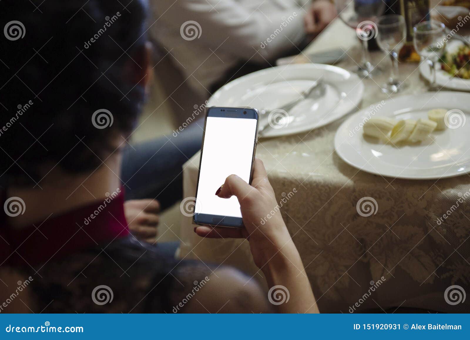 Woman Sits at the Table and Looks into the Phone Screen Stock Image ...