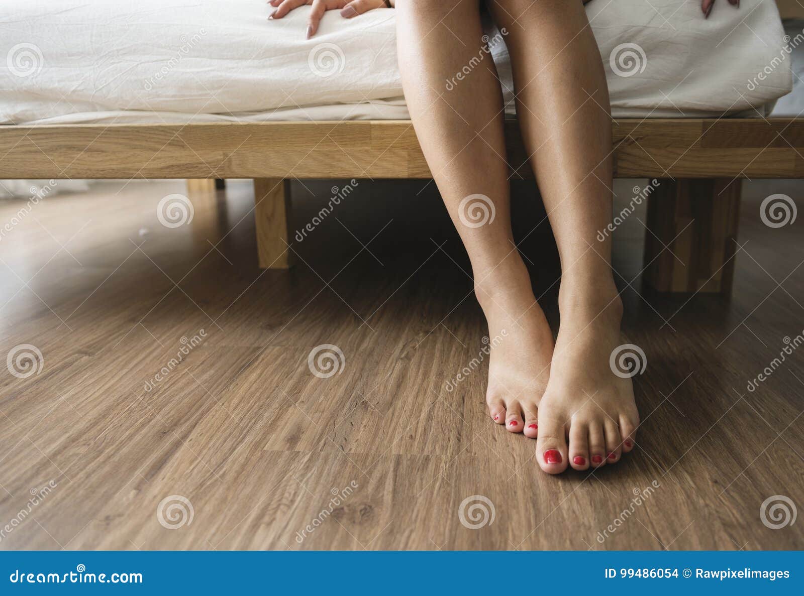 Woman sitting on the bed stock photo. Image of interior - 99486054