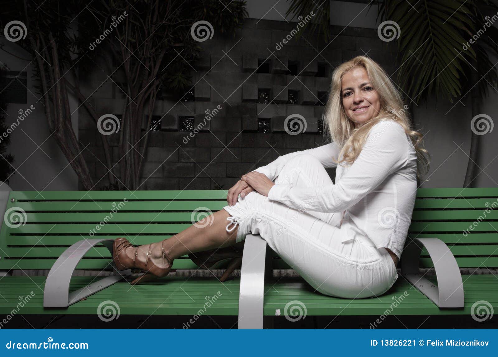 Woman sitting on a bench stock image. Image of woman - 13826221