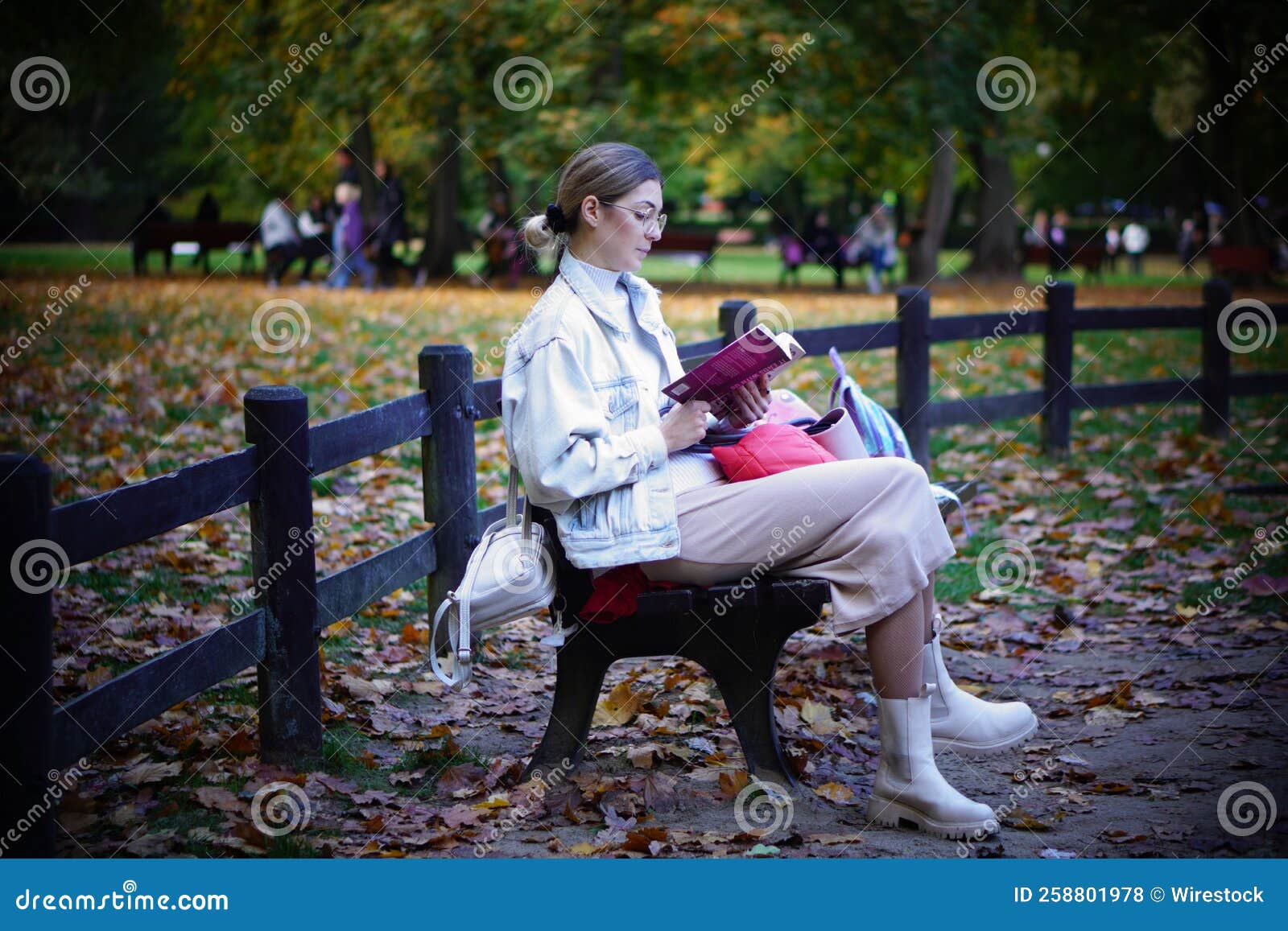 Woman Sitting On A Bench And Reading A Book In The Solacki Park On A
